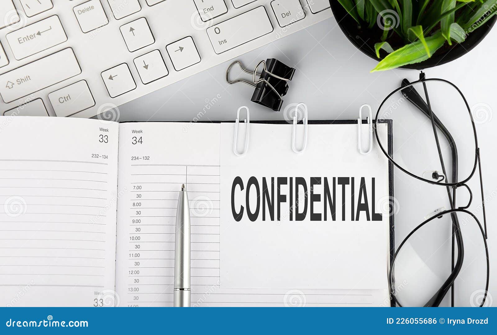 Text CONFIDENTIAL Stickers on the Notebook with Keyboard and Glasses ...