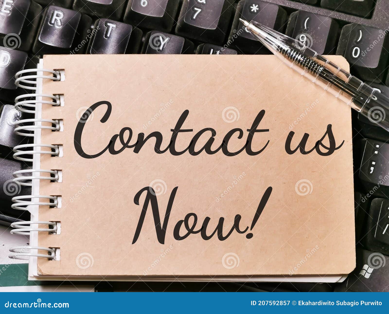 Text CONTACT US NOW Written on Brown Paper Note on Computer Keyboard ...