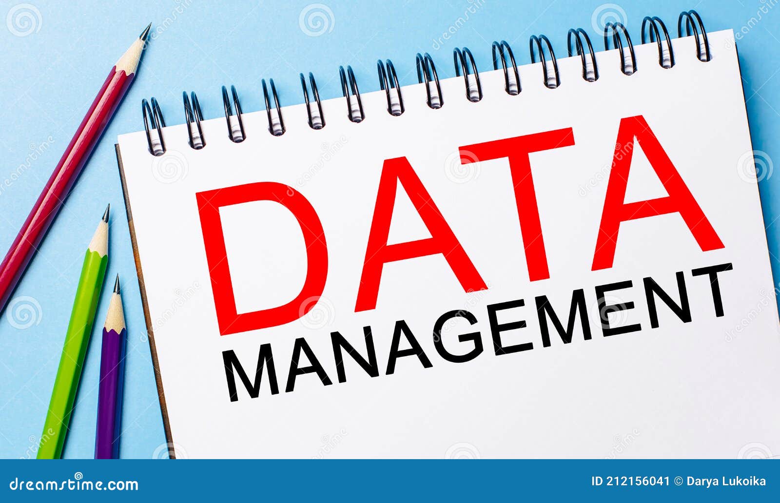 Text DATA MANAGEMENT on a White Notepad with Pencils on a Blue ...