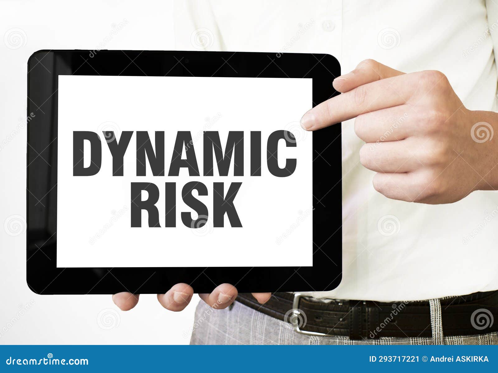 Text DYNAMIC RISK on Tablet Display in Businessman Hands on the White ...