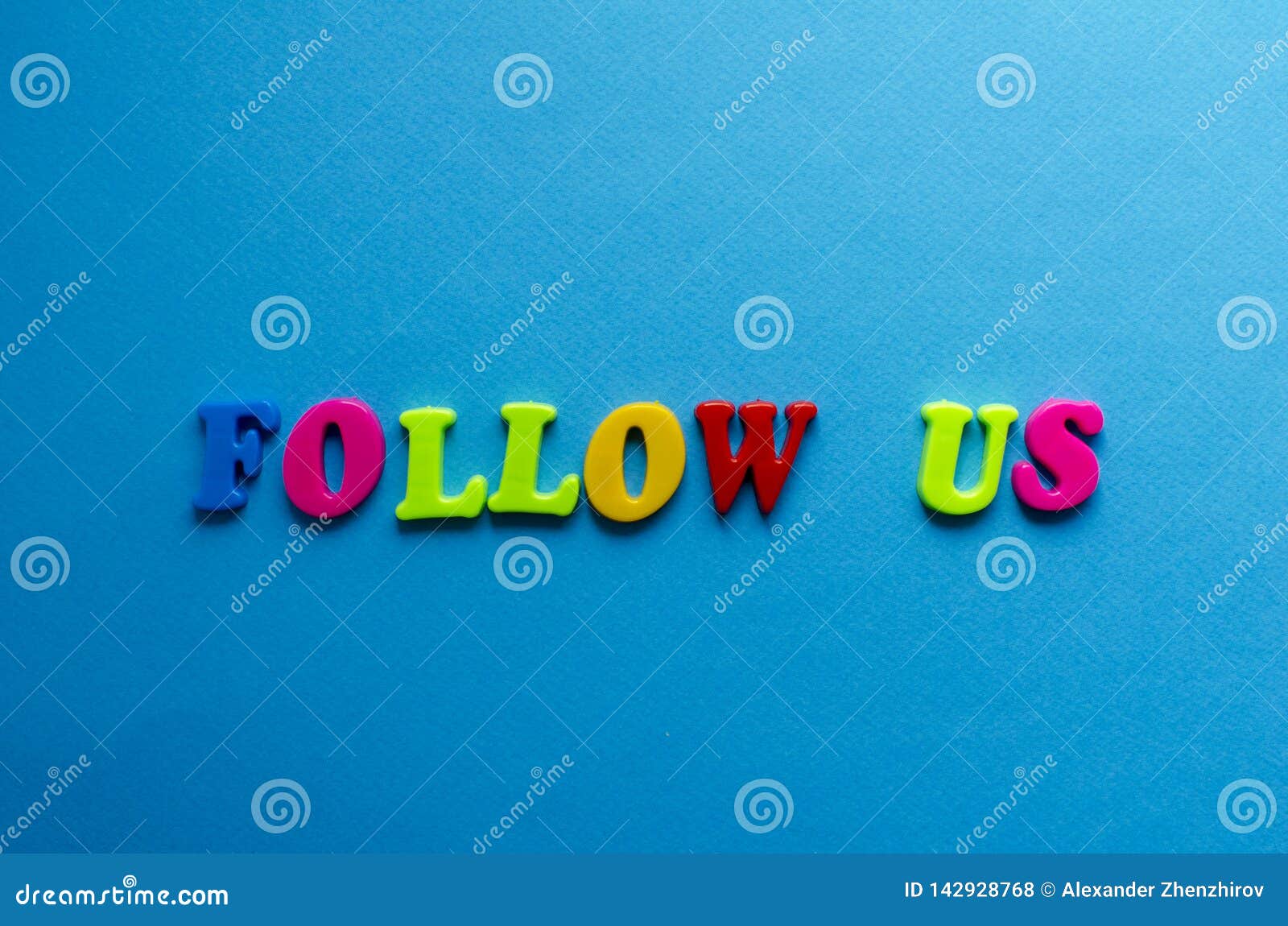 Text Follow Us from Plastic Colored Letters on Blue Paper Background ...