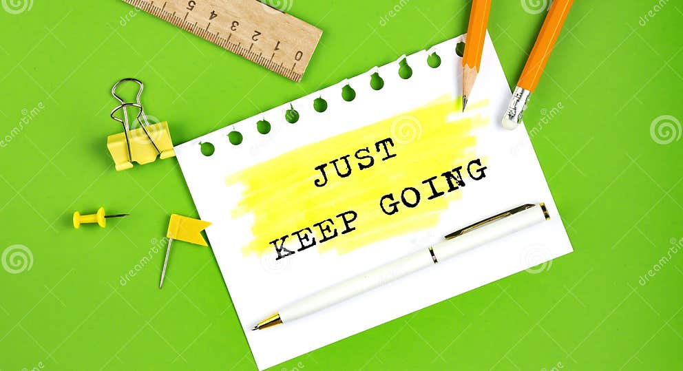 Text JUST KEEP GOING Sign Showing on Green Background with Office Tools ...