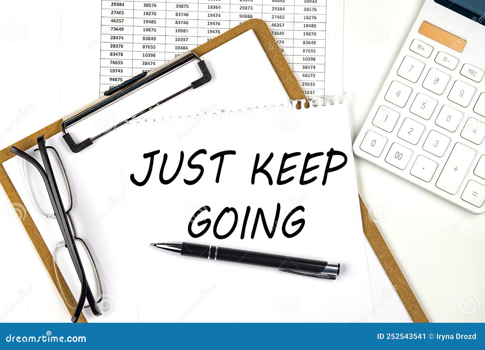 Text JUST KEEP GOING on the White Paper on Clipboard with Chart and ...