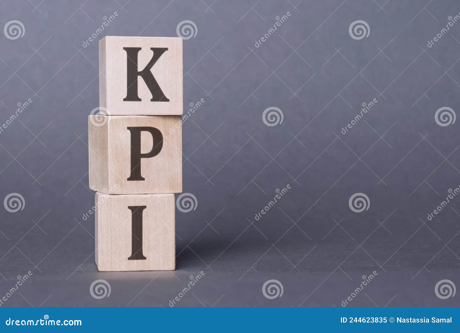 Text KPI on Wood Blocks on Dark Gray Background. Key Performance ...