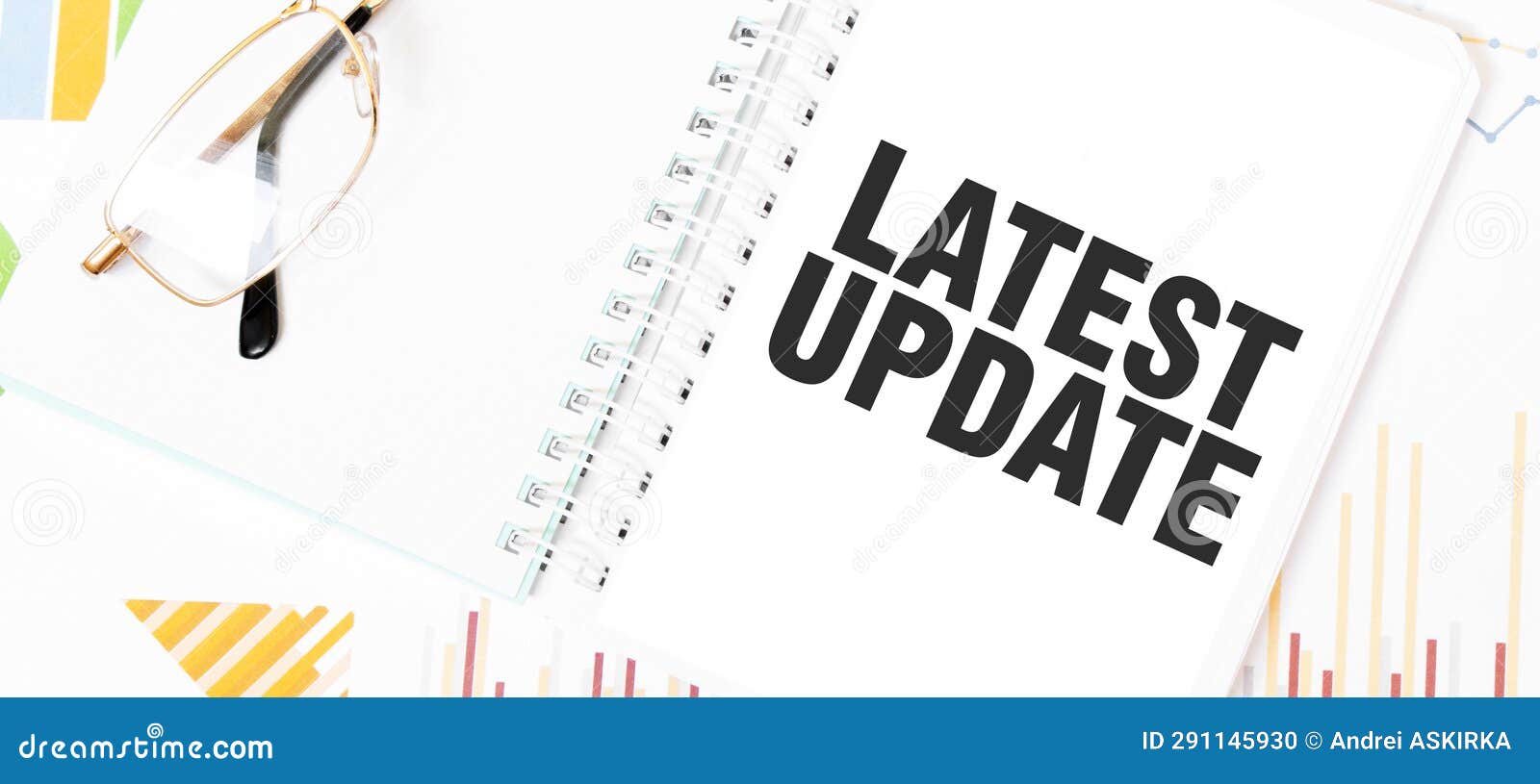 Text LATEST UPDATE on White Notepad, Glasses, Graphs and Diagrams Stock ...