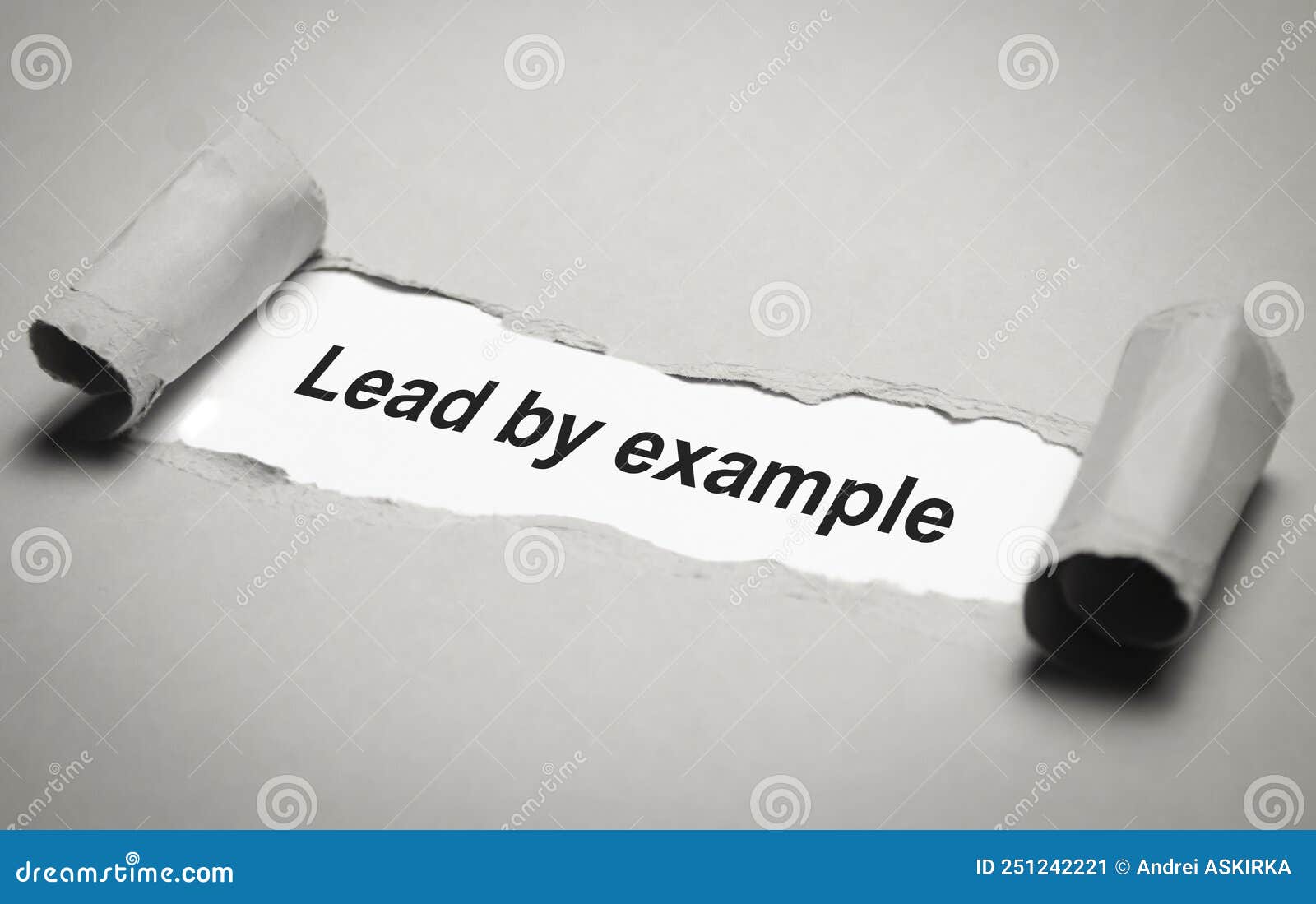 The Text Lead by Example Appearing Behind Torn Grey Paper Stock Image ...