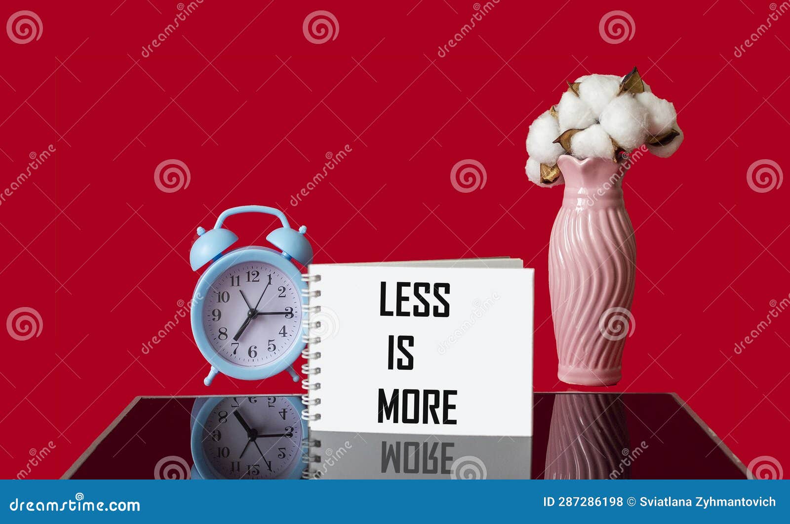 Text less is More Scale Concept on Red and Black Background Stock Photo ...