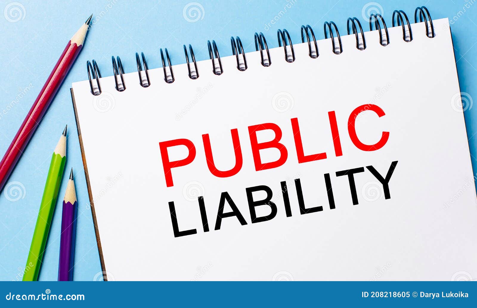 Text PUBLIC LIABILITY on a White Notepad with Pencils on a Blue ...