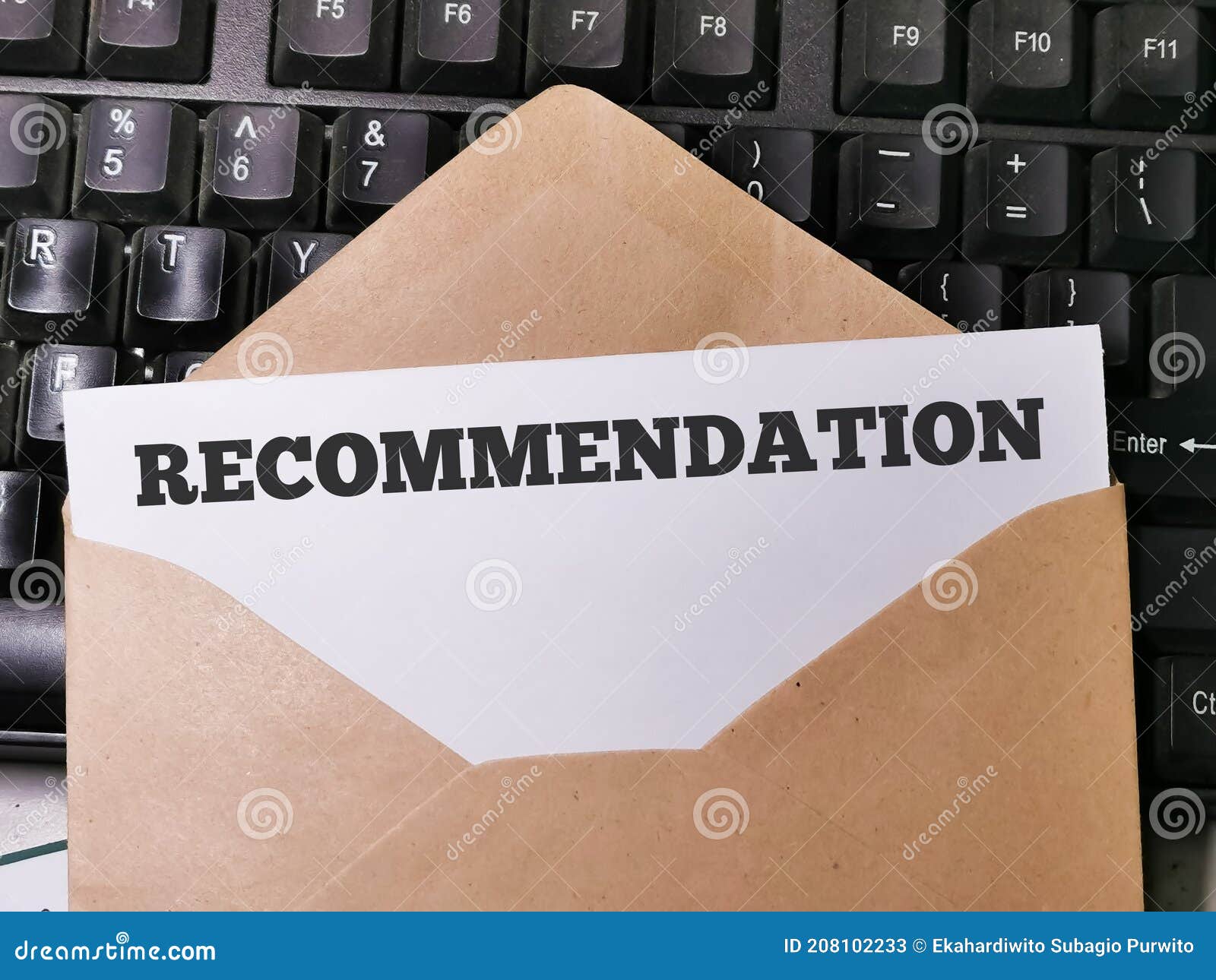 Text RECOMMENDATION Written on White Paper Note in the Envelope on ...
