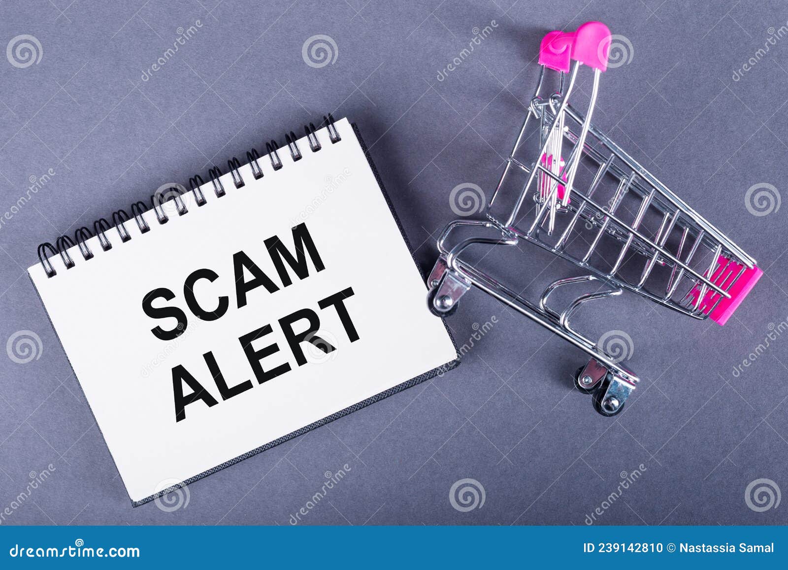 The Text SCAM ALERT is Written on a Notebook, Next To a Trolley on Gray ...