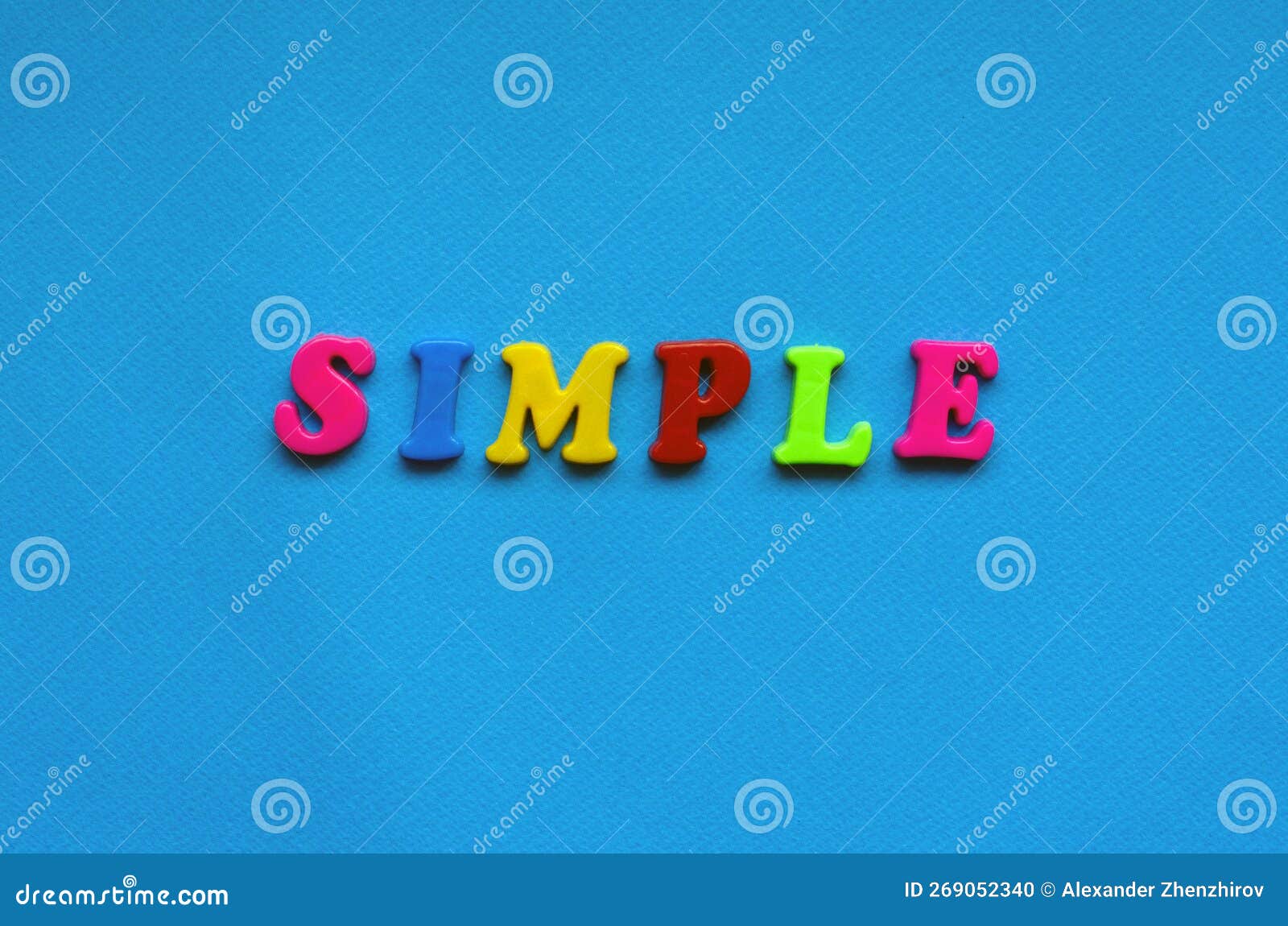 Text Simple from Plastic Colored Letters on Blue Paper Background ...
