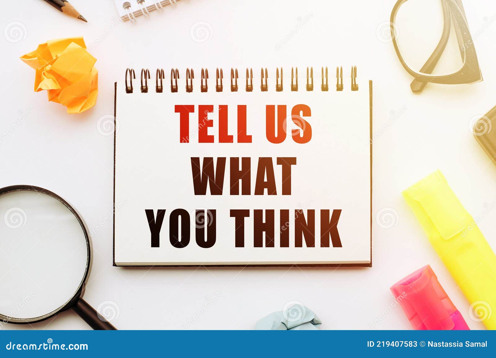 Text Tell Us What You Think in Notebook on White Table with Office ...