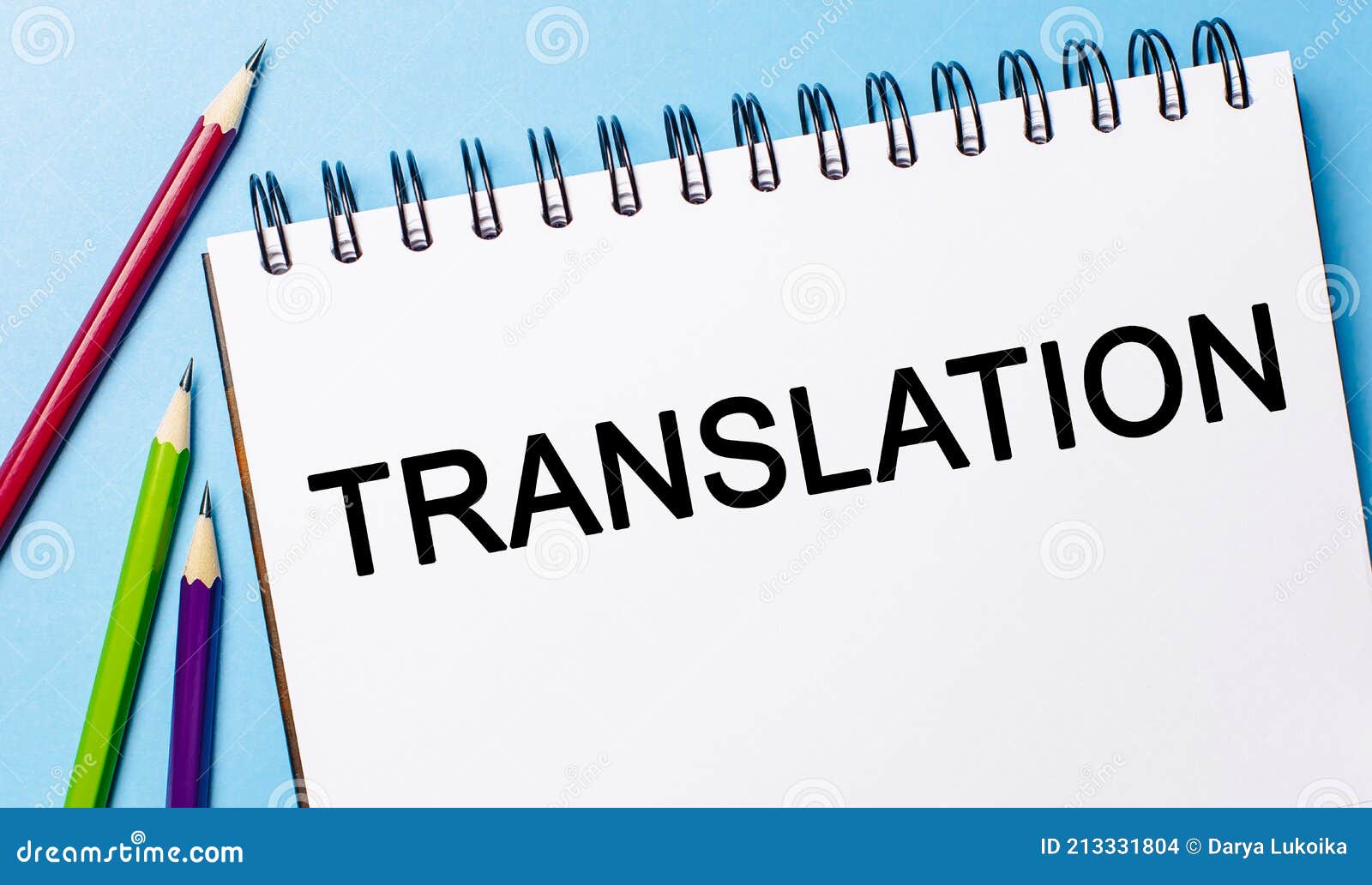 Text TRANSLATION on a White Notepad with Pencils on a Blue Background ...