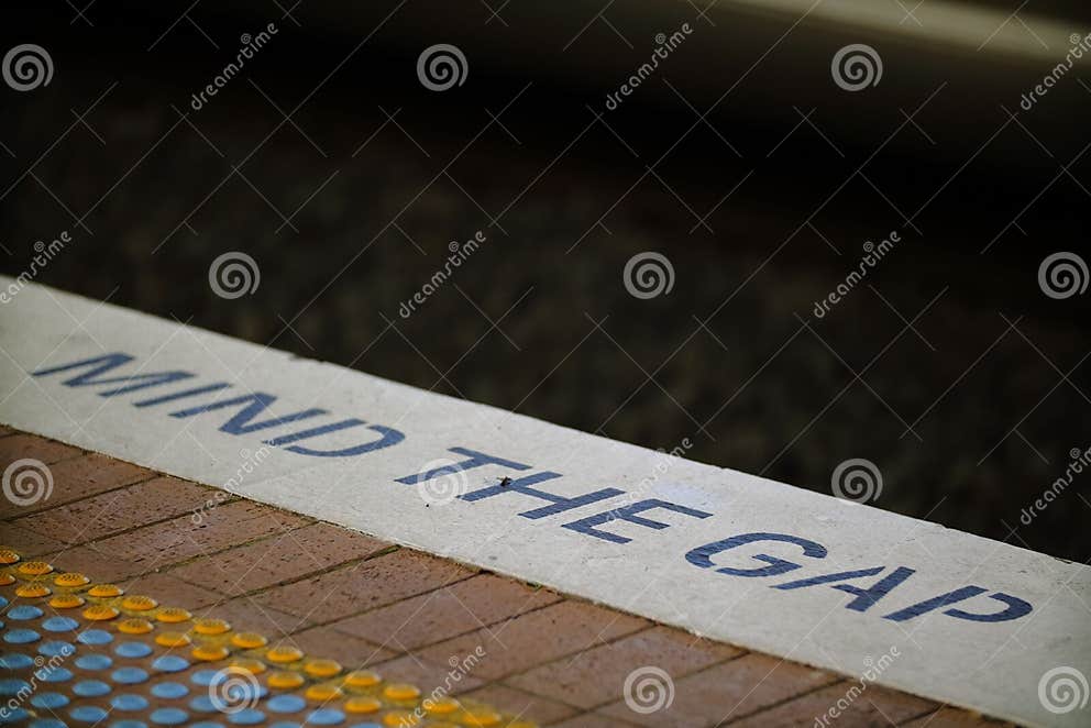 Text Warning MIND the GAP on Stone Platform on Train or Metro Station ...