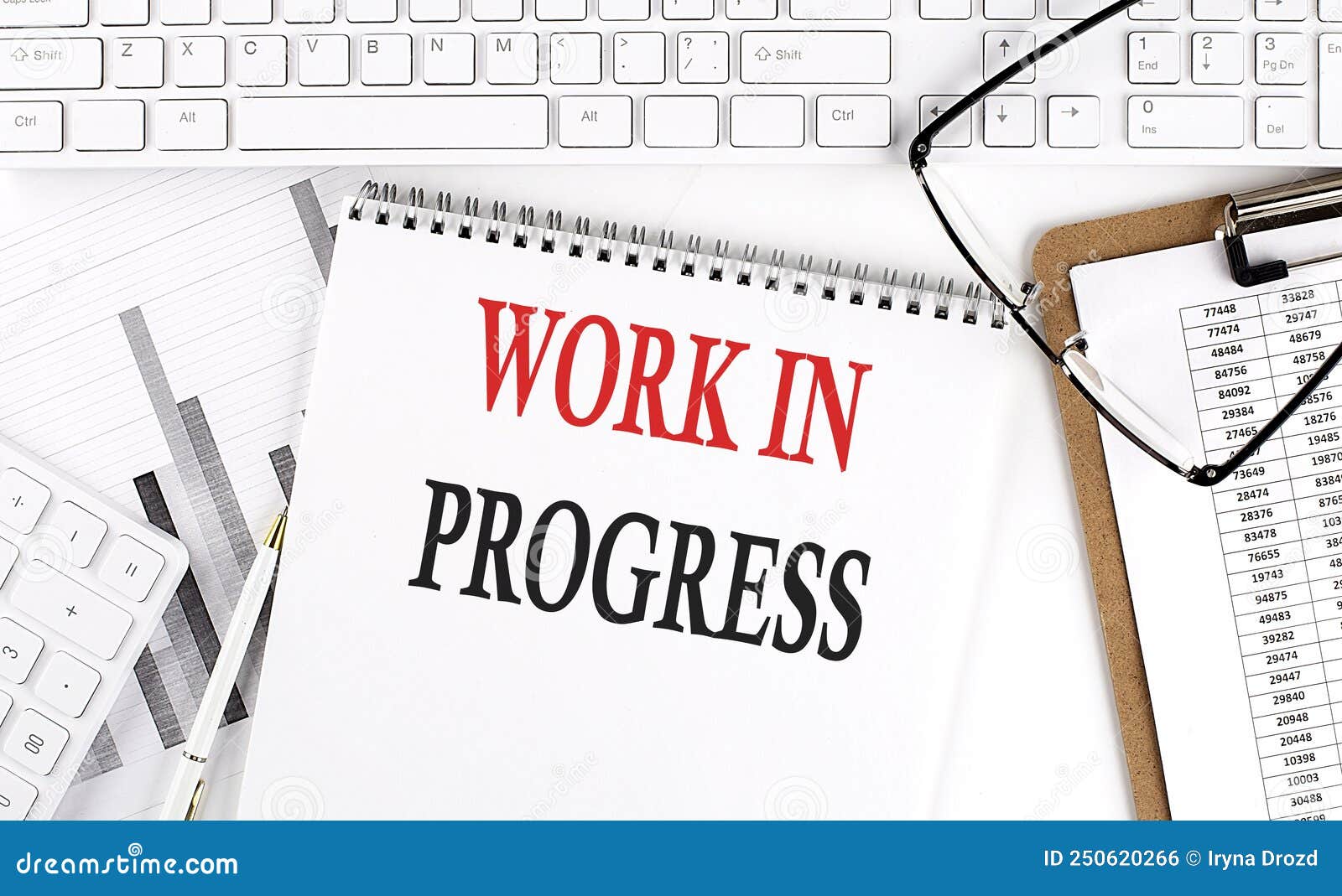 Text WORK in PROGRESS on Office Desk Table with Keyboard, Notepad and ...