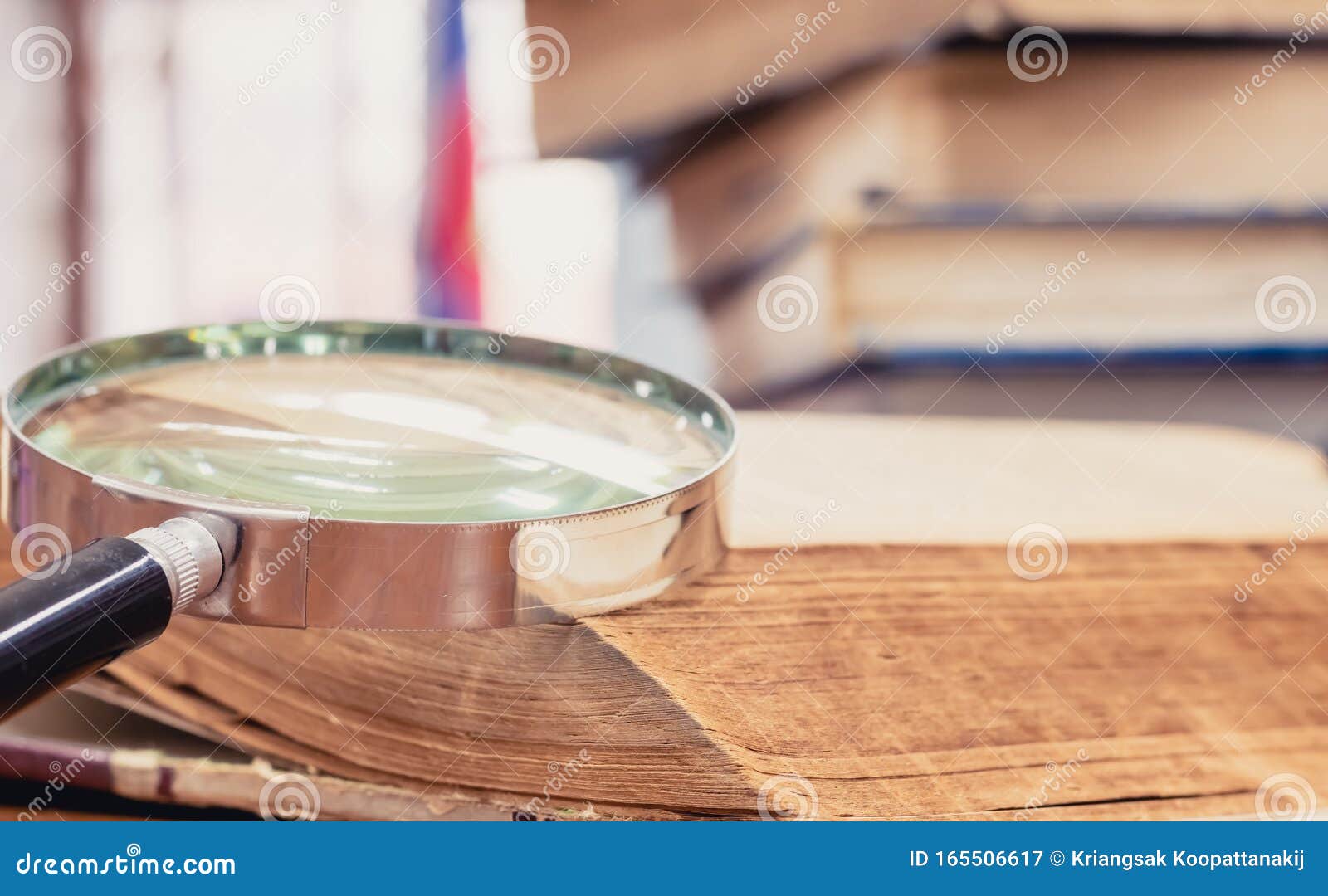 Textbook Stack with Magnifying Glass on Wooden Table with Blur ...