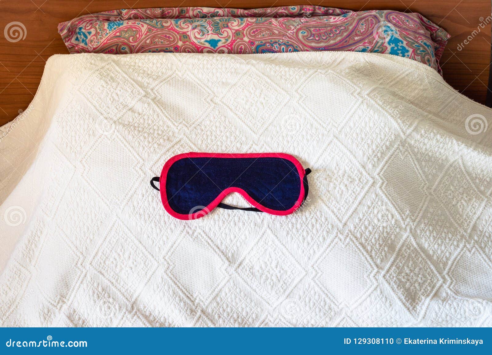 Textile sleep mask on bed stock photo. Image of sewn - 129308110