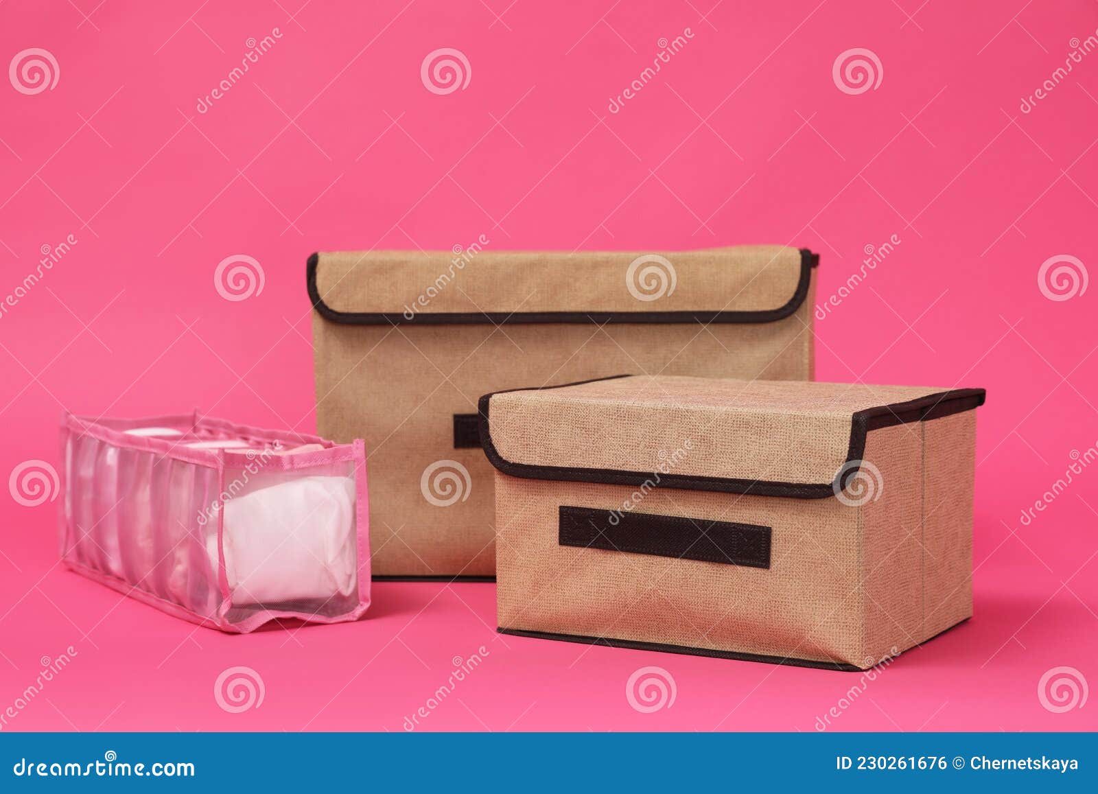 Textile Storage Cases and Organizer with Folded Clothes on Pink ...