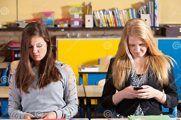 Texting in classroom stock image. Image of students, brunette - 17522809
