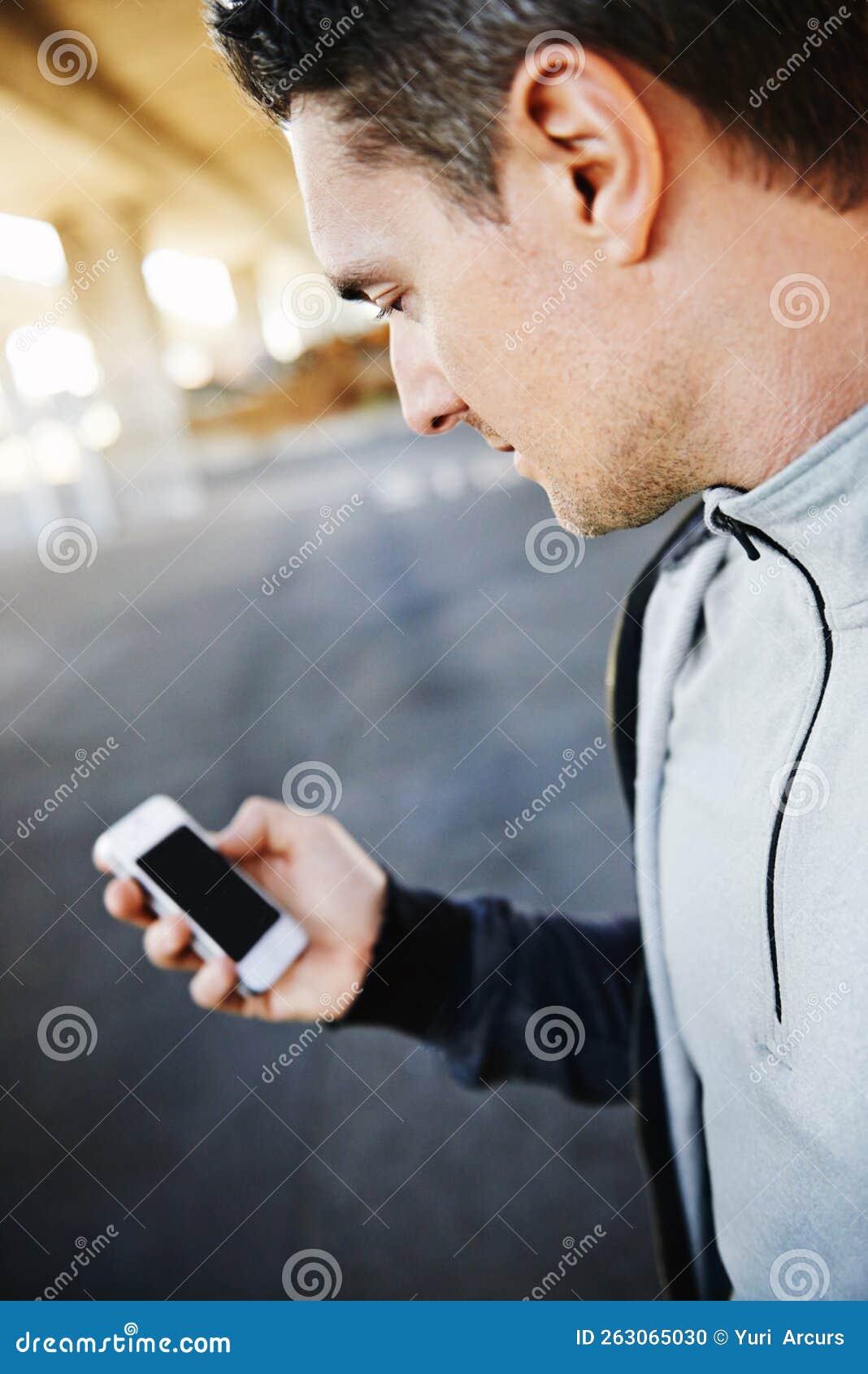 Texting on the Go. Side View of a Young Man Checking Something on His ...