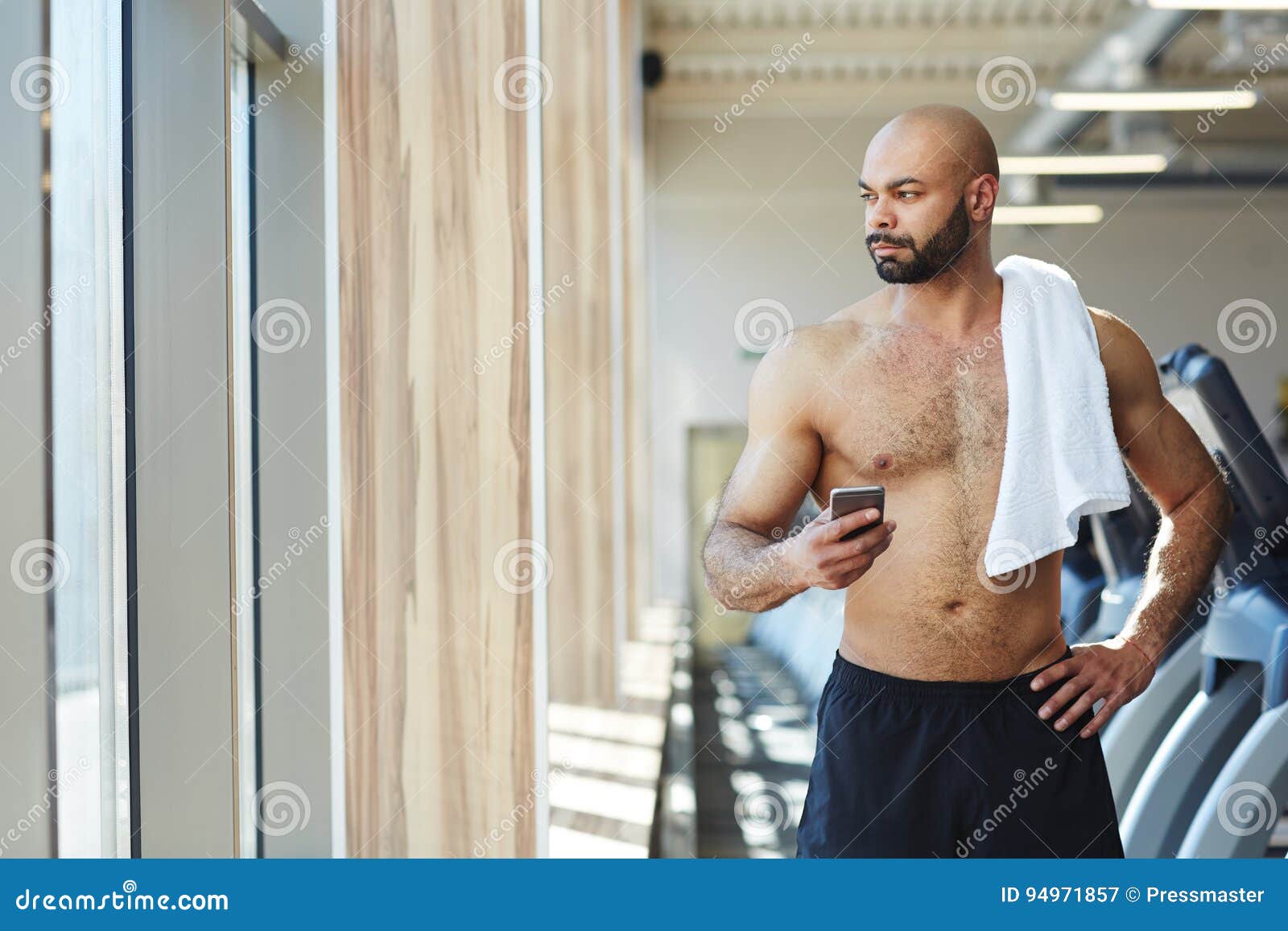 Texting in gym stock image. Image of messaging, towel - 94971857