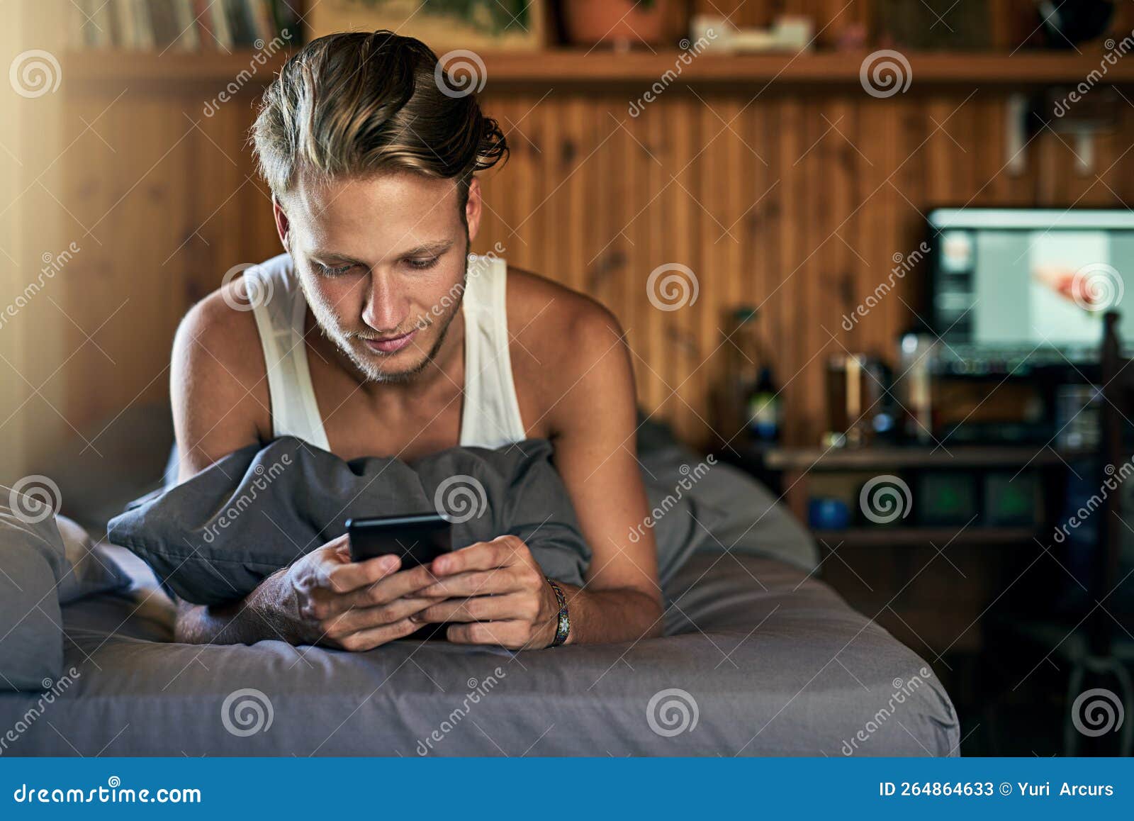 Texting is a Part of His Morning Routine. a Young Man Texting on His ...