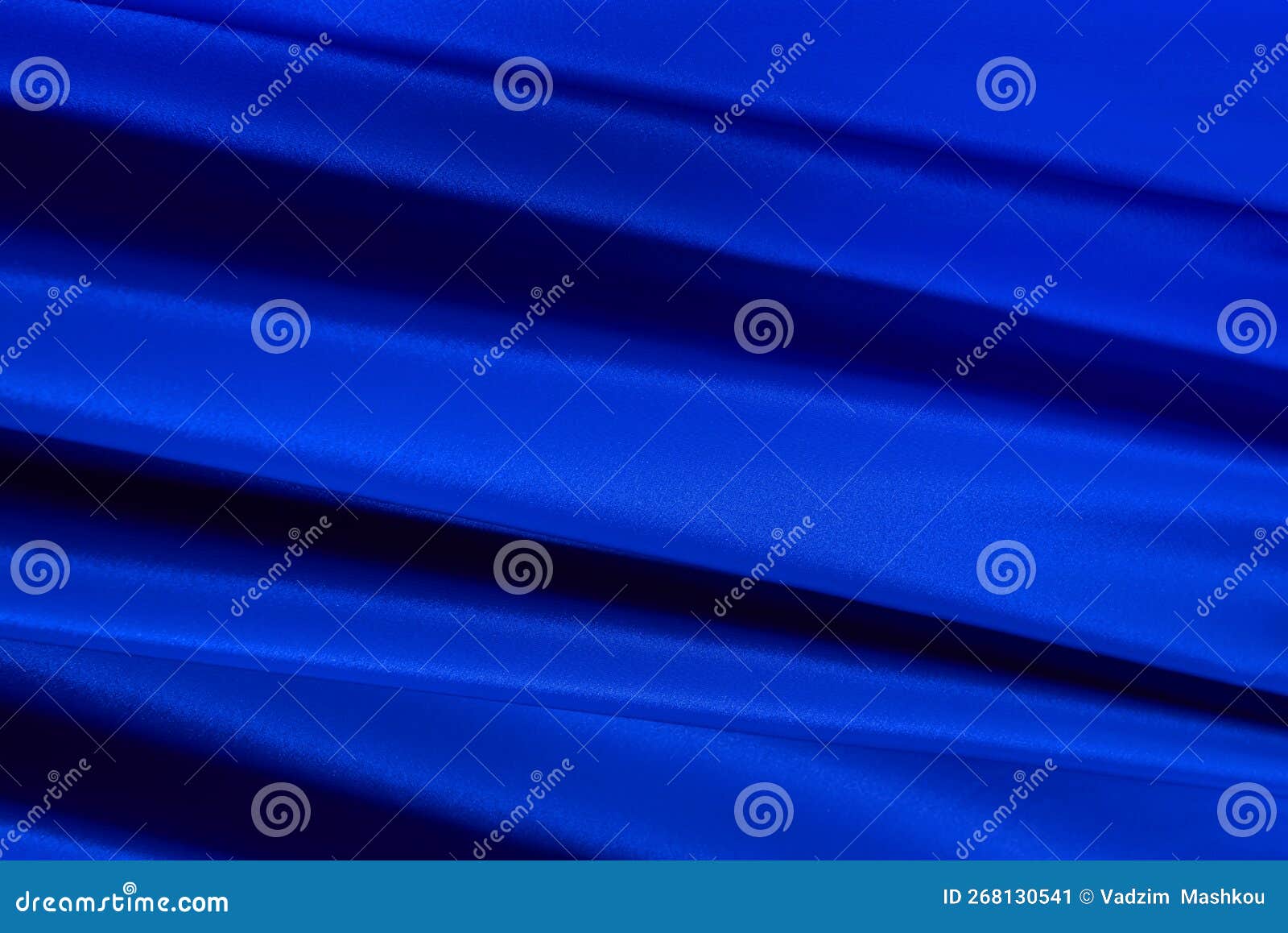 The Texture of a Luxurious Smooth Fabric in Blue with Folds and Waves ...