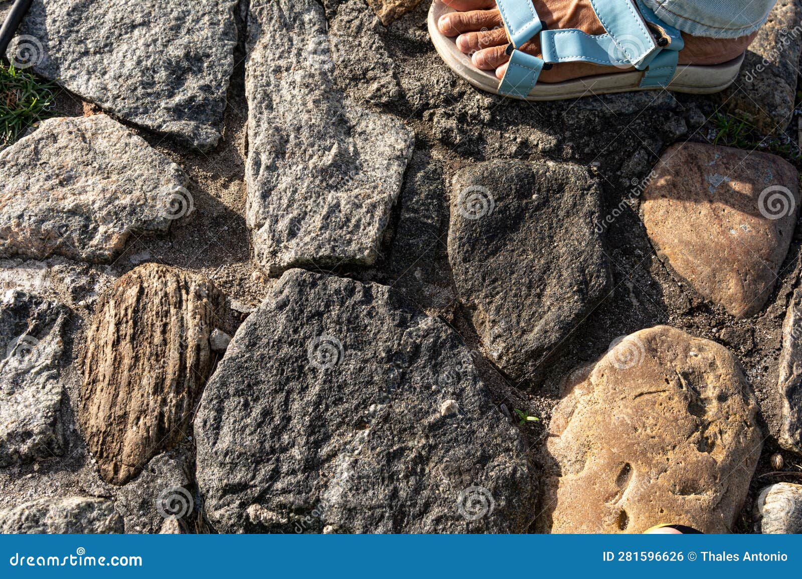Texture of Stones on the Ground. a Human Foot Treads the Ground Stock ...