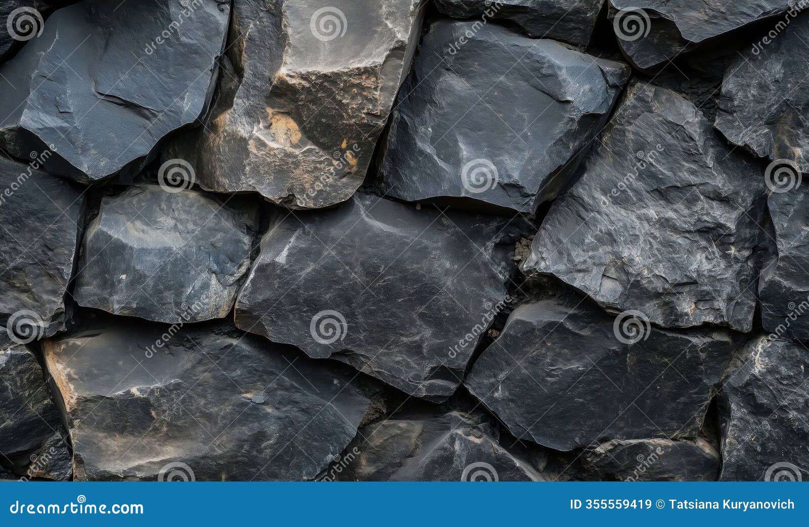 Textured Black Stone Wall with Irregularly Shaped Rocks Creating a ...