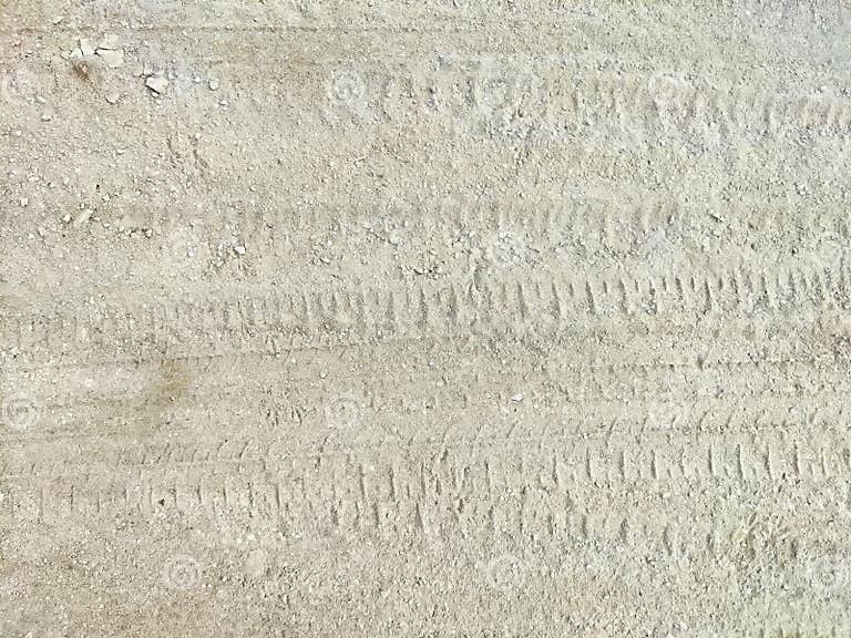 A Textured Dirt Surface Features Prominent Tire Tracks, Providing Ample ...