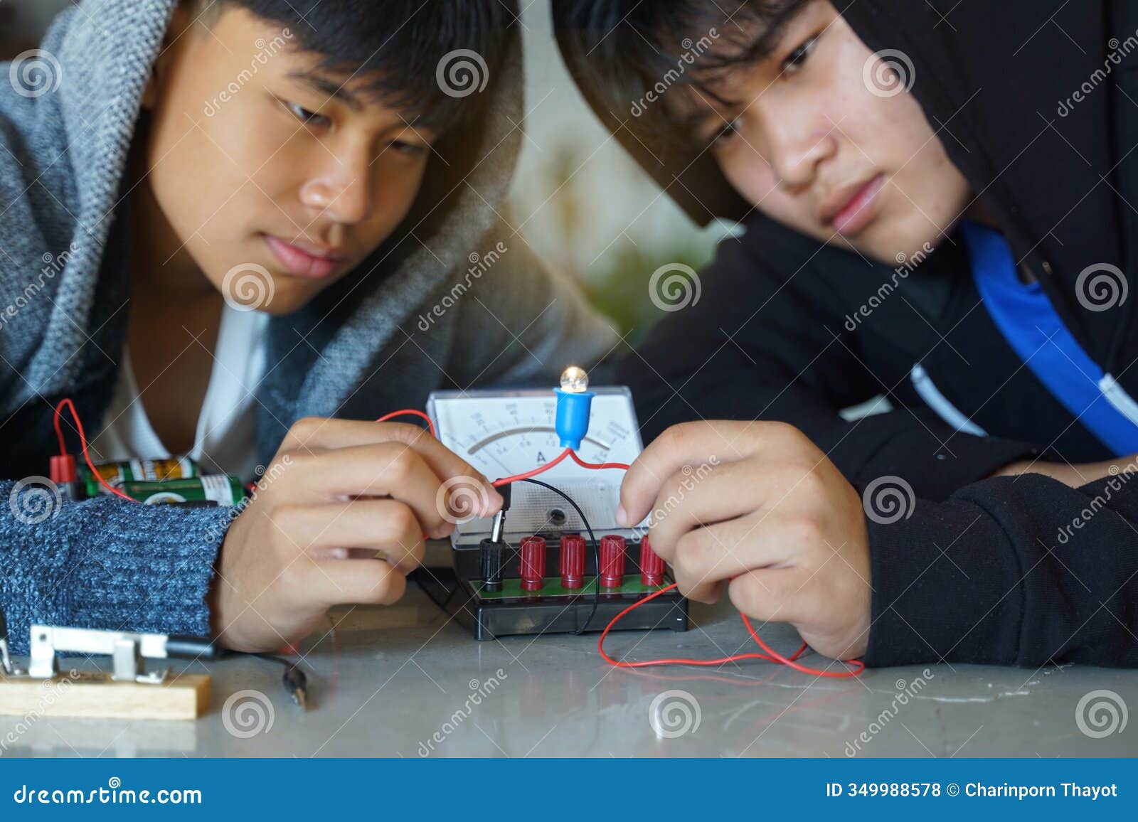 Thai Boy Performs an Outdoor Science Experiment on Connecting a Simple ...