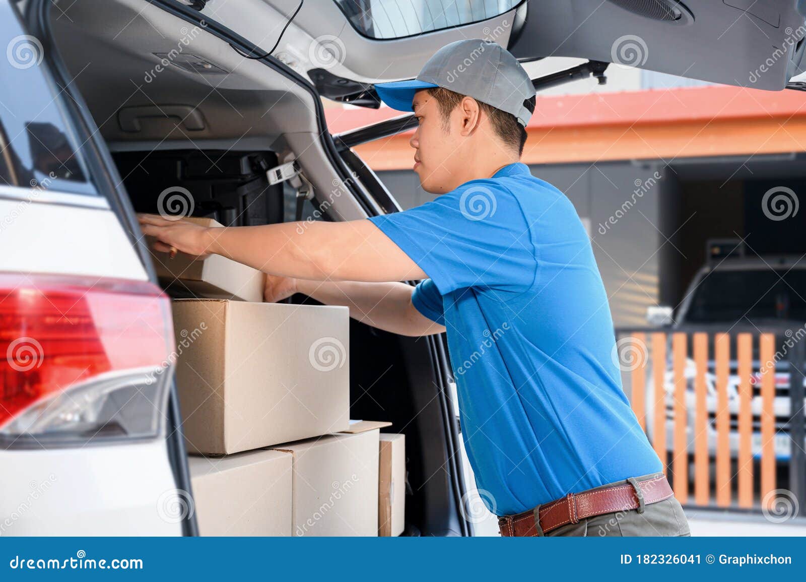 Thai Mailman Checking Parcel and Mail Boxes for Home Delivery. Stock ...