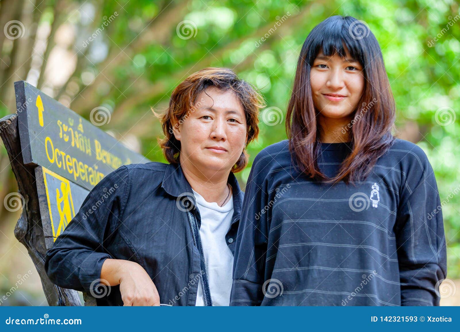 Thai Mother And Her Daughter Standing And Hugging On The Stone Of