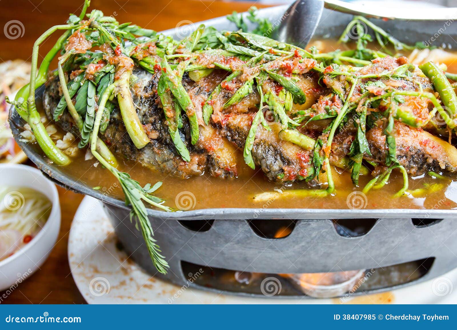 Fried Snake Head Fish And Egg Stuffed Climbing Wattle In Spicy Sour ...