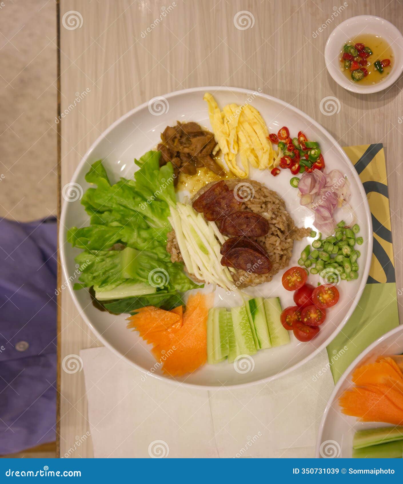Thai Style Fried Rice with Assorted Sides and Vegetables on the Table ...