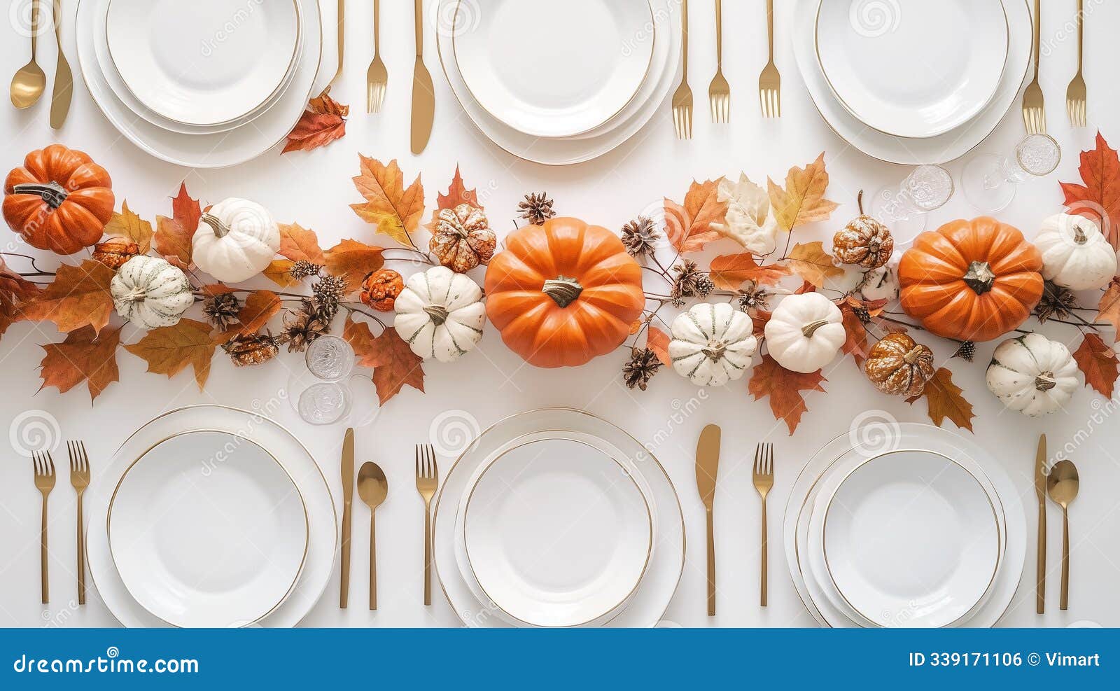 A Thanksgiving Table Setting with Pumpkins, Leaves, and Plates Stock ...