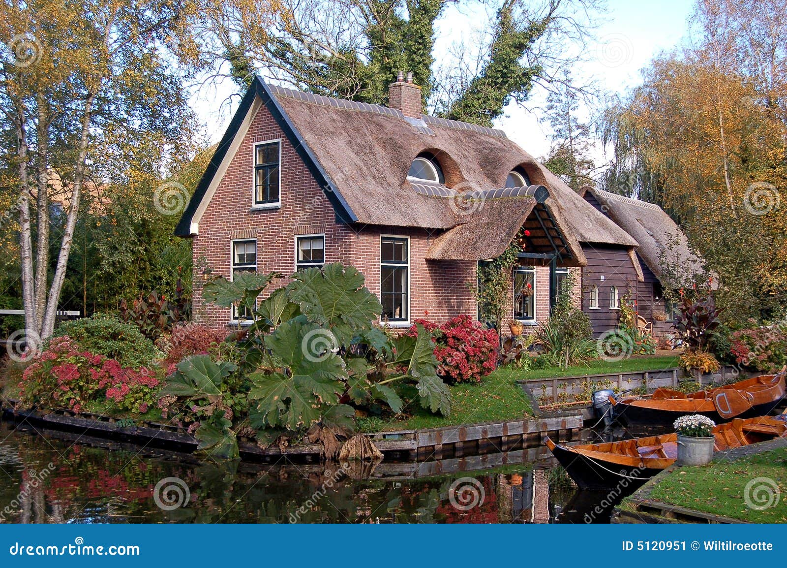 Thatched house and boats stock image. Image of country - 5120951