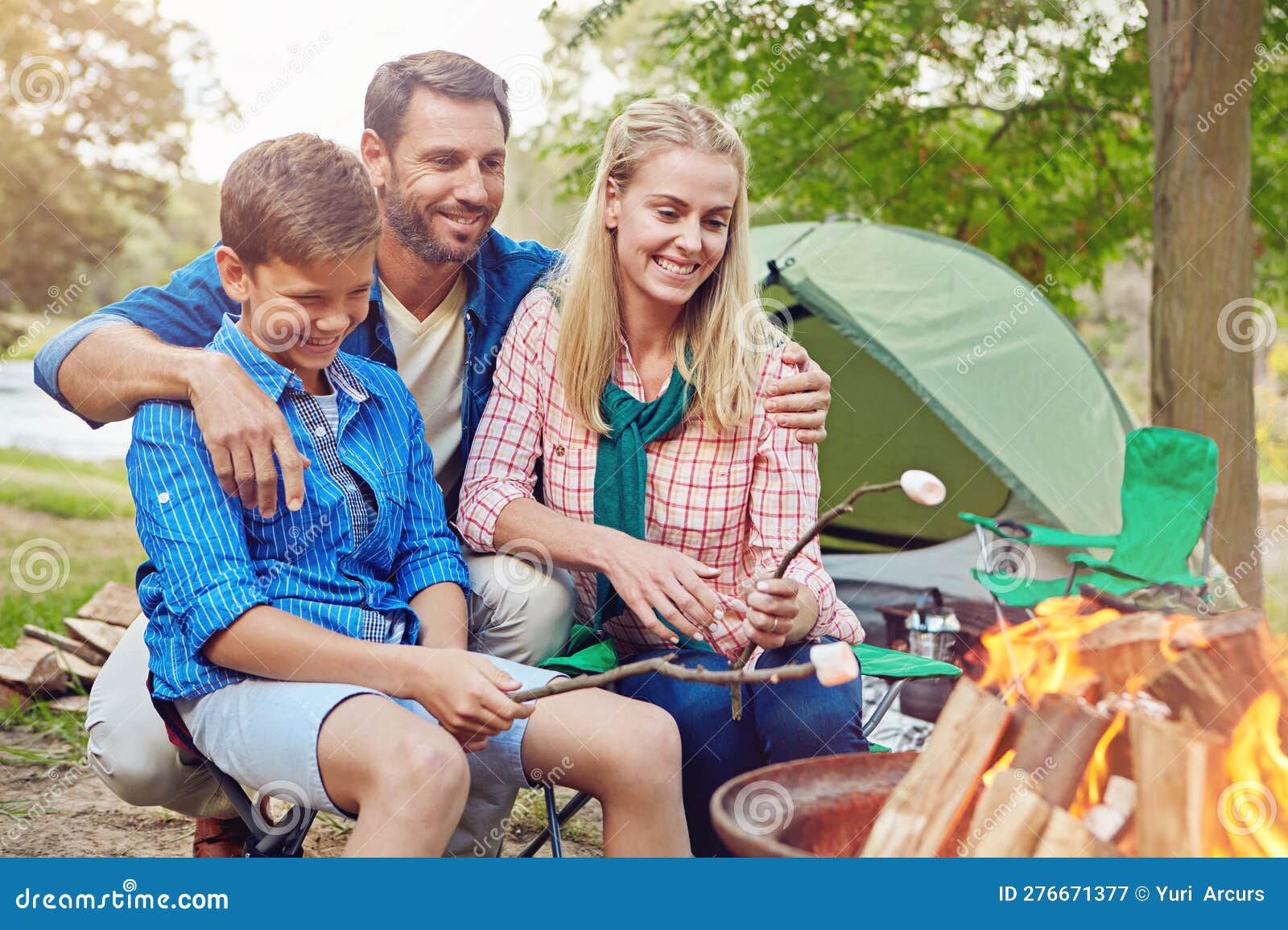 Thats a Great Campfire. a Family of Three Camping in the Woods. Stock ...