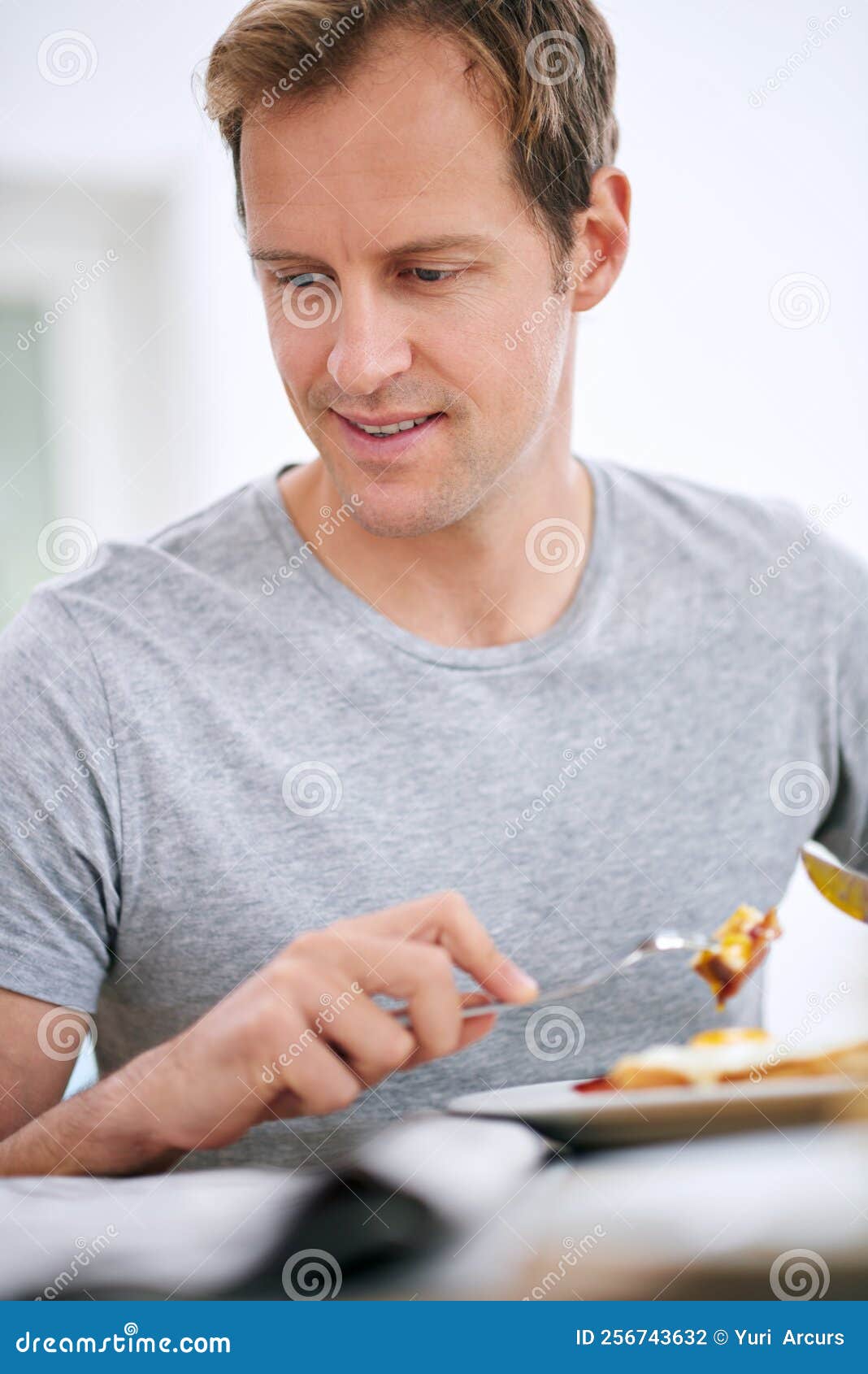 Thats Interesting...a Handsome Man Reading the Paper while Eating ...