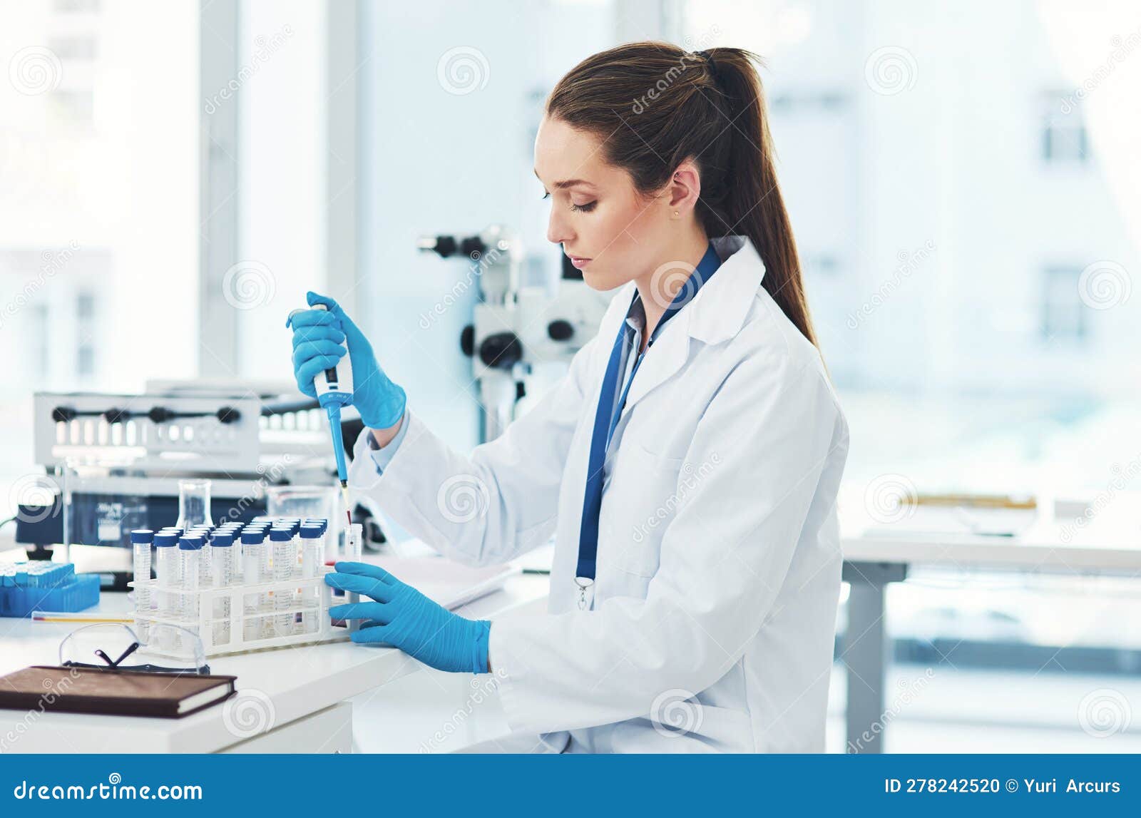 Thats One Done. a Focused Young Female Scientist Pouring a Test Sample ...
