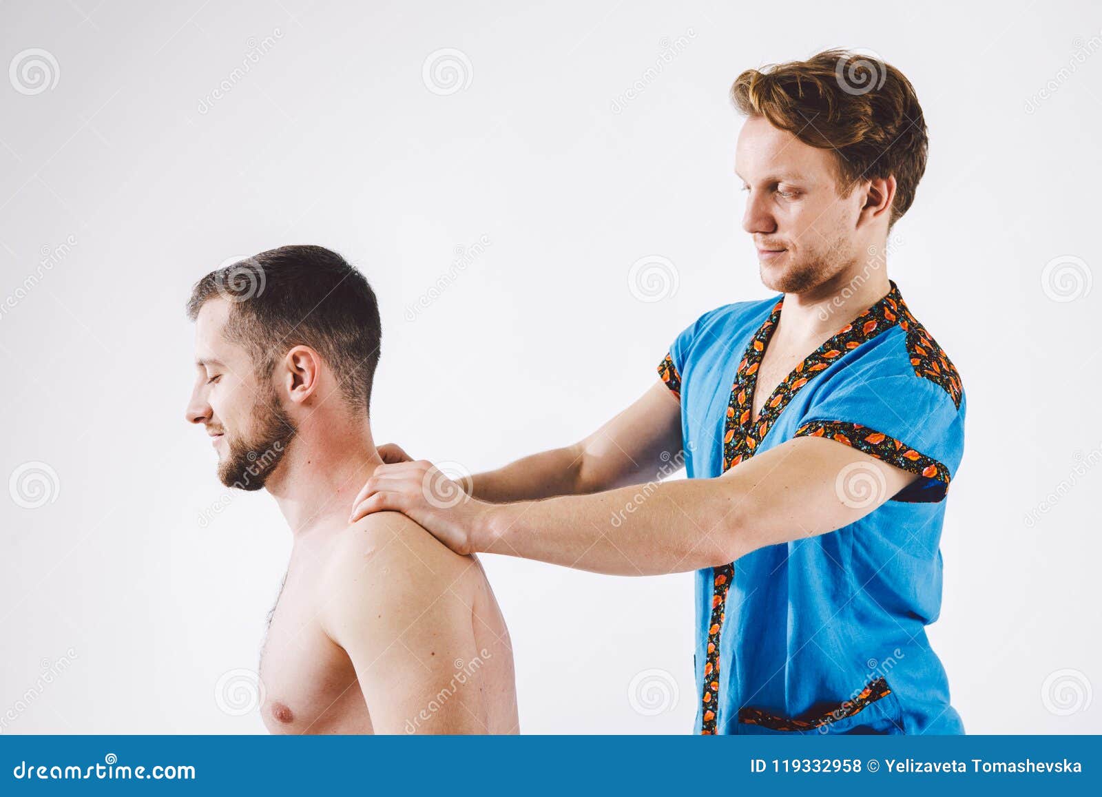 Theme Massage And Body Care A Handsome Caucasian Male Doctor In Blue