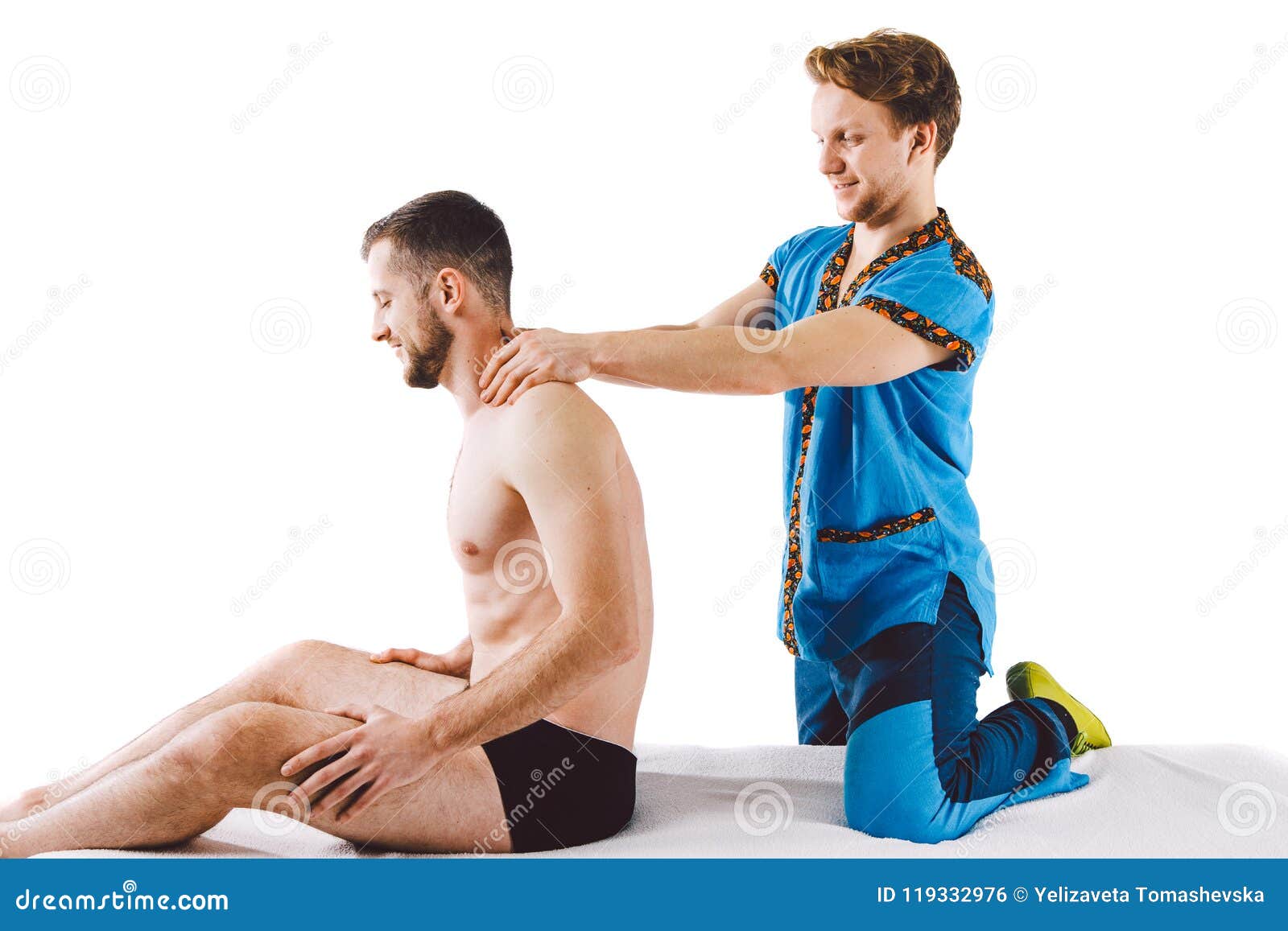 Theme Massage And Body Care A Handsome Caucasian Male Doctor In Blue