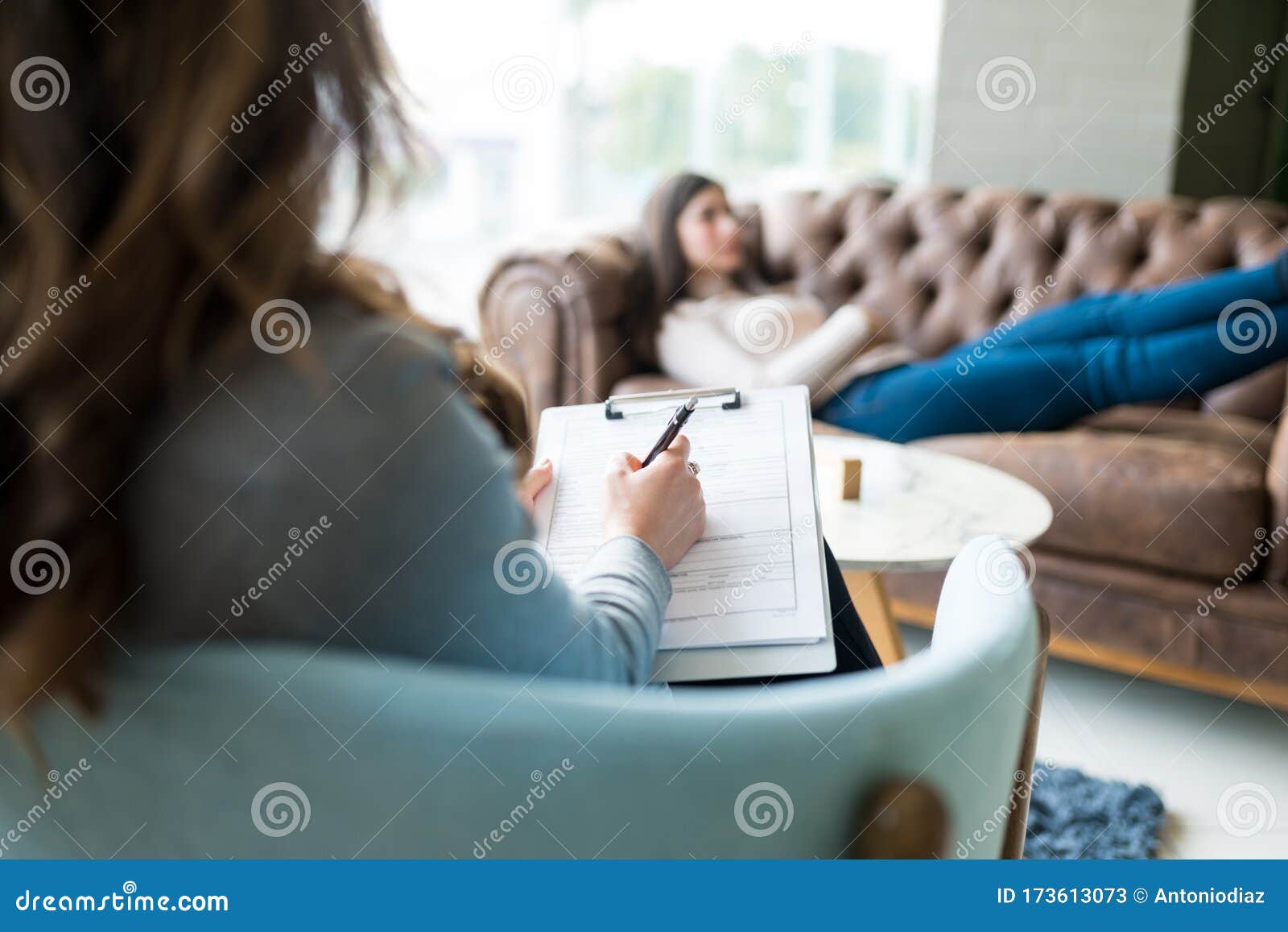 Therapist Counseling Patient and Making Notes at Office Stock Image ...