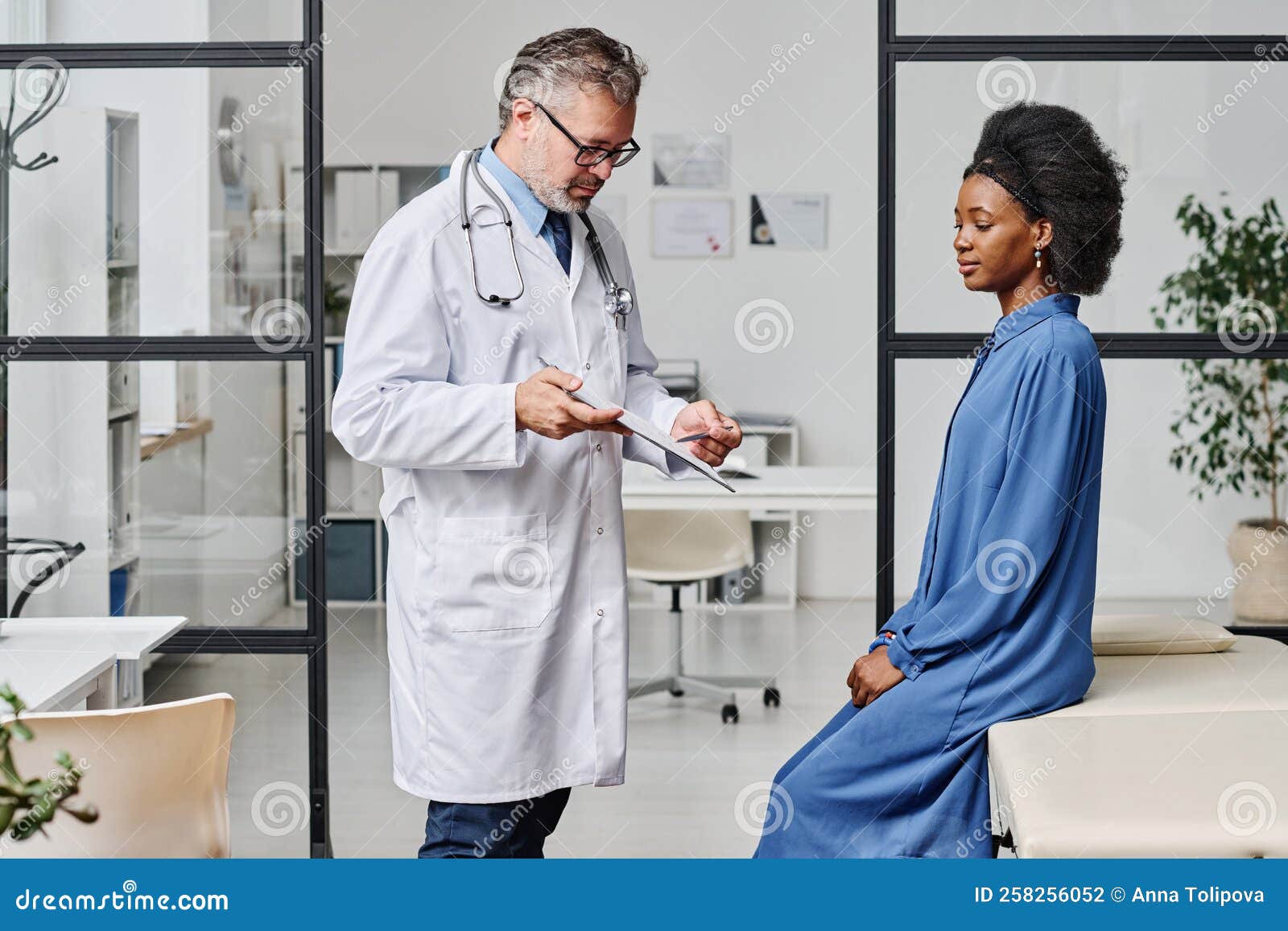 Therapist Explaining Treatment with Patient Stock Photo - Image of ...