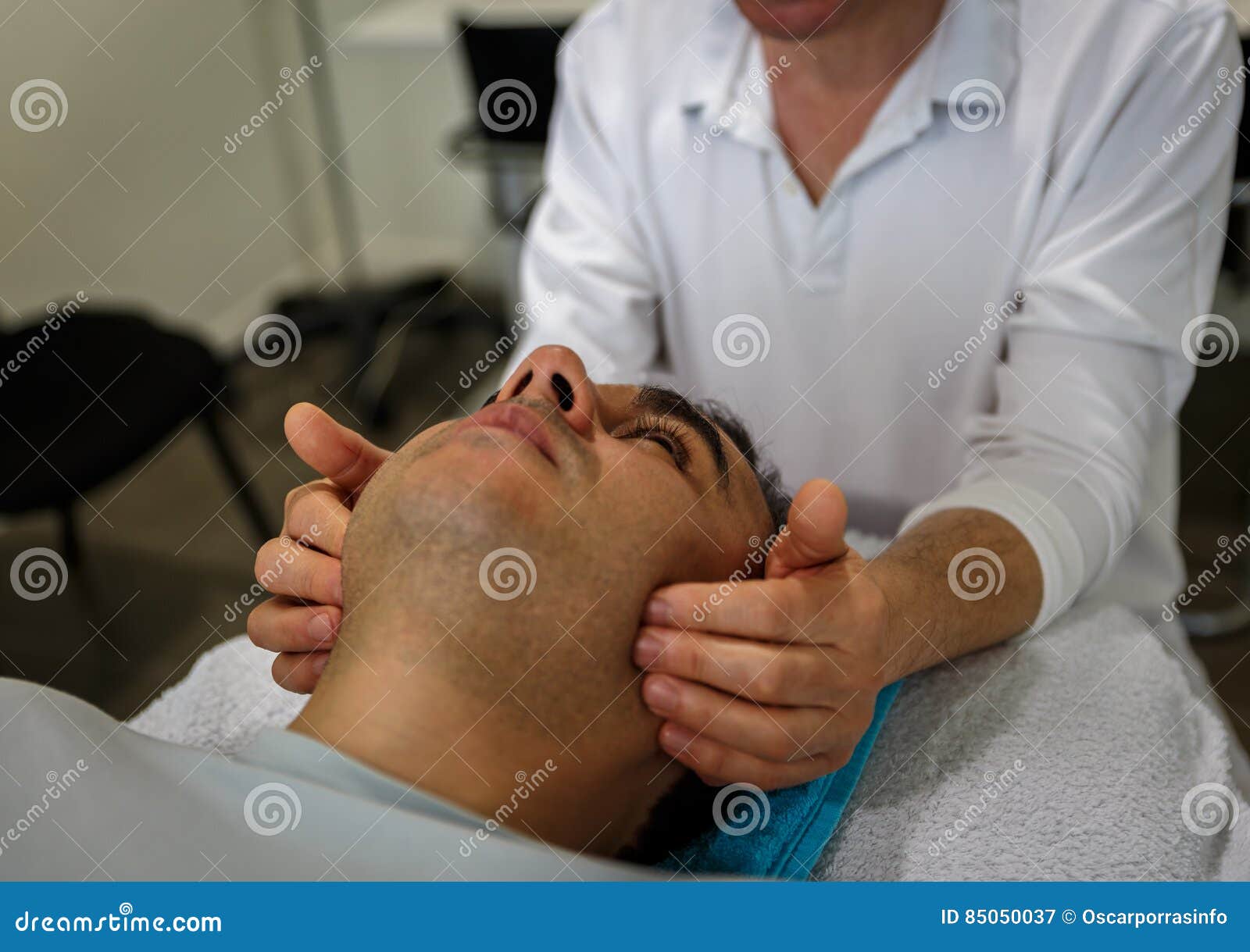 A Therapist Places His Hands on the Sides of a Man`s Face Stock Image ...