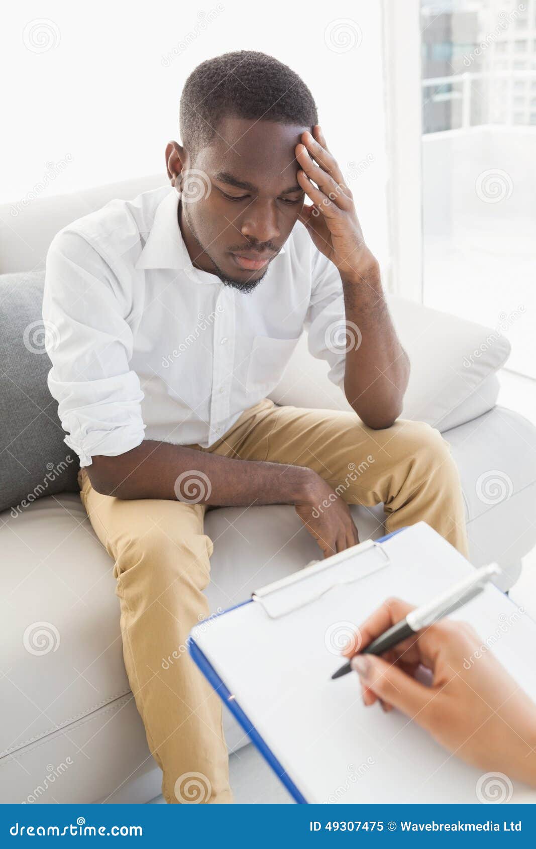 Therapist Taking Notes on Her Depressed Patient Stock Image - Image of ...