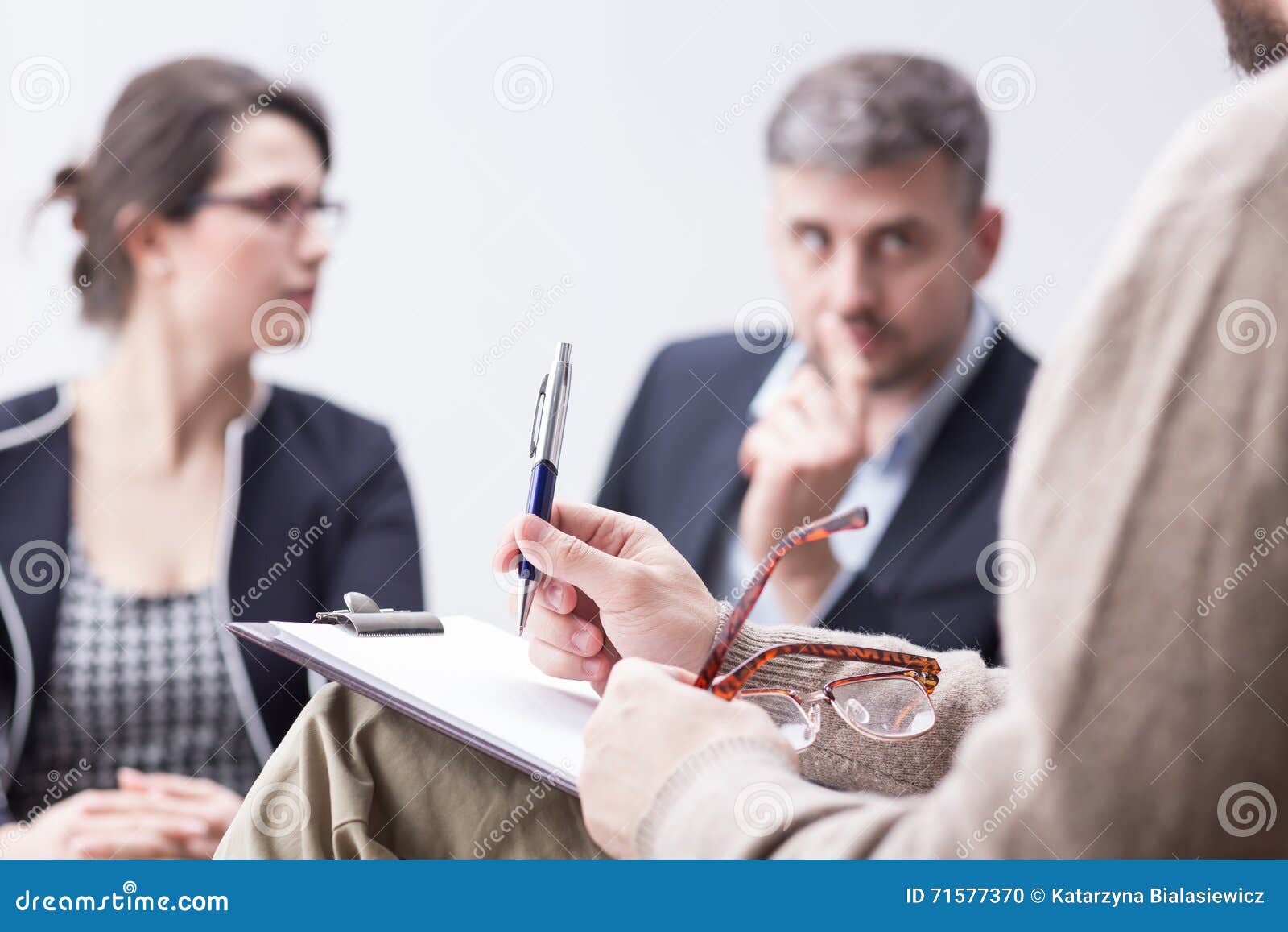 Therapist Taking Notes during Marriage Therapy Session Stock Photo ...