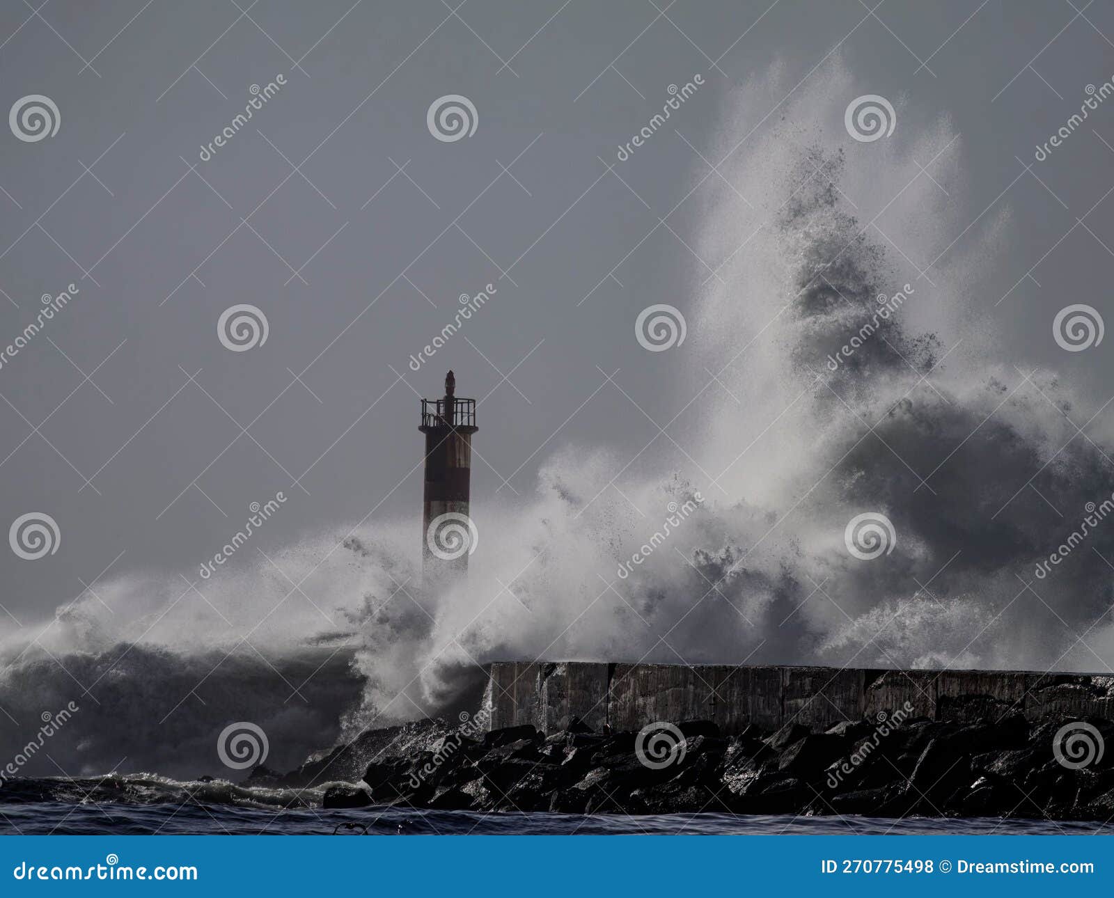 There is a Big Wave Hitting the Rocks at the End of the Pier Stock ...