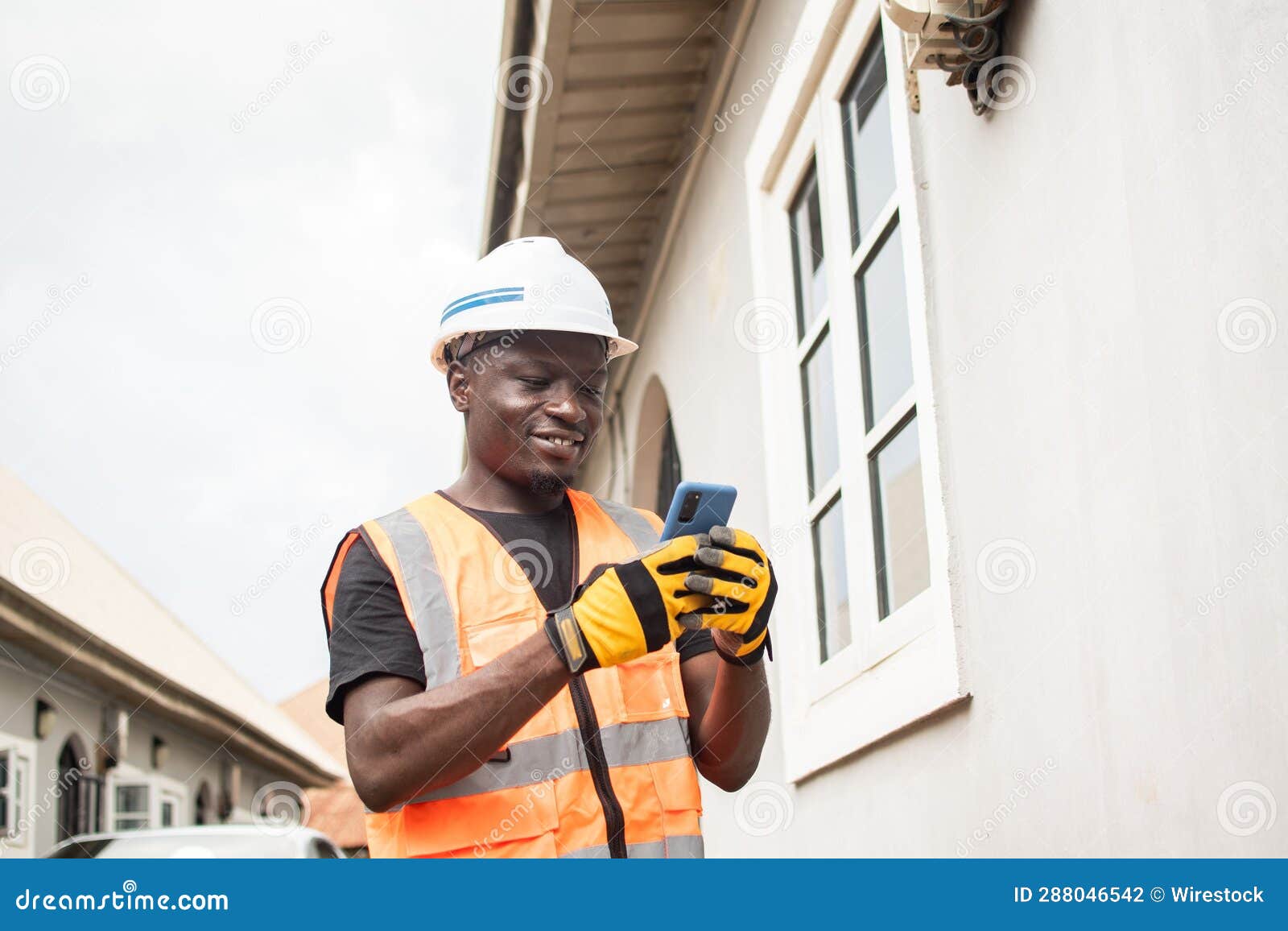 There is a Construction Worker Using His Phone To Check Something Stock ...