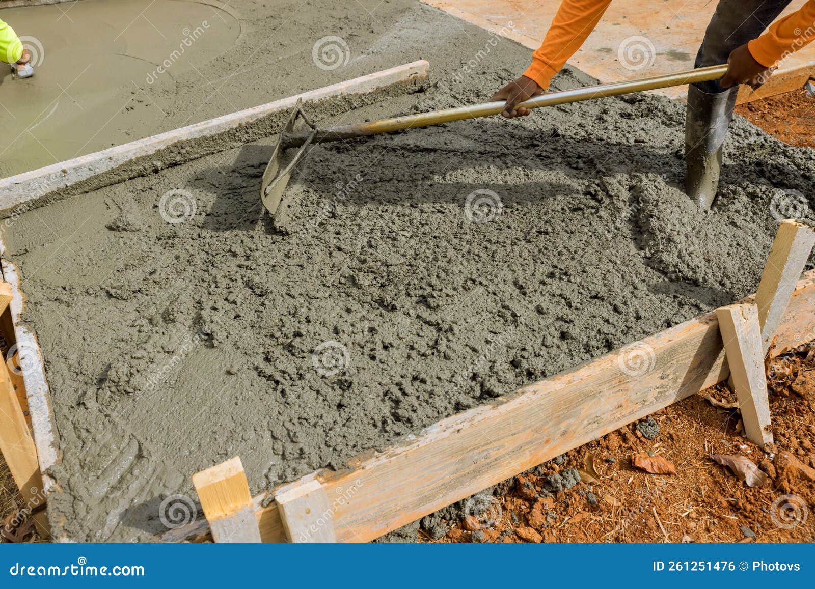 There are Construction Workers Pouring Cement on the Side of the House ...